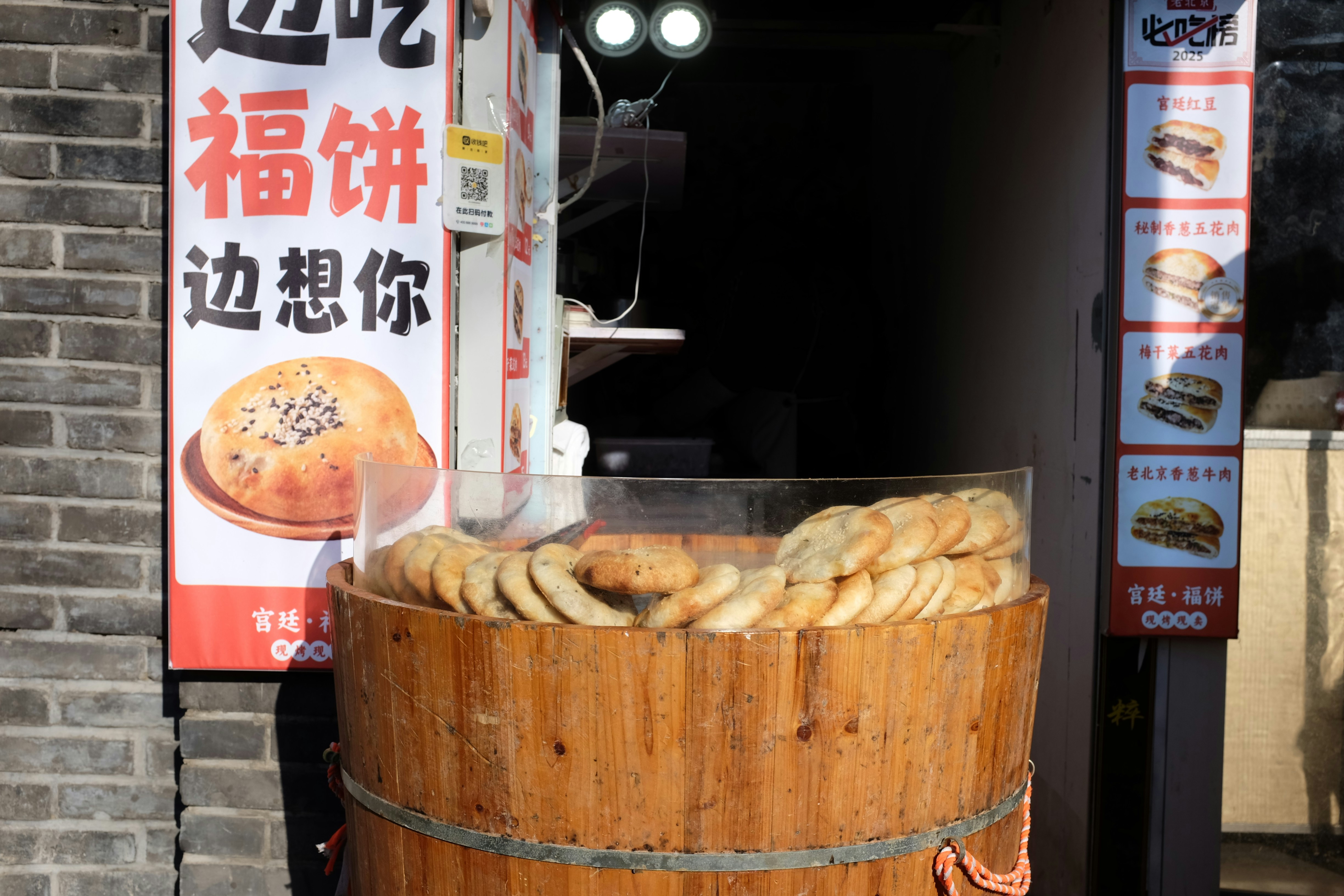 Steaming Barrel of Pastry Rounds at a Street Food Stall