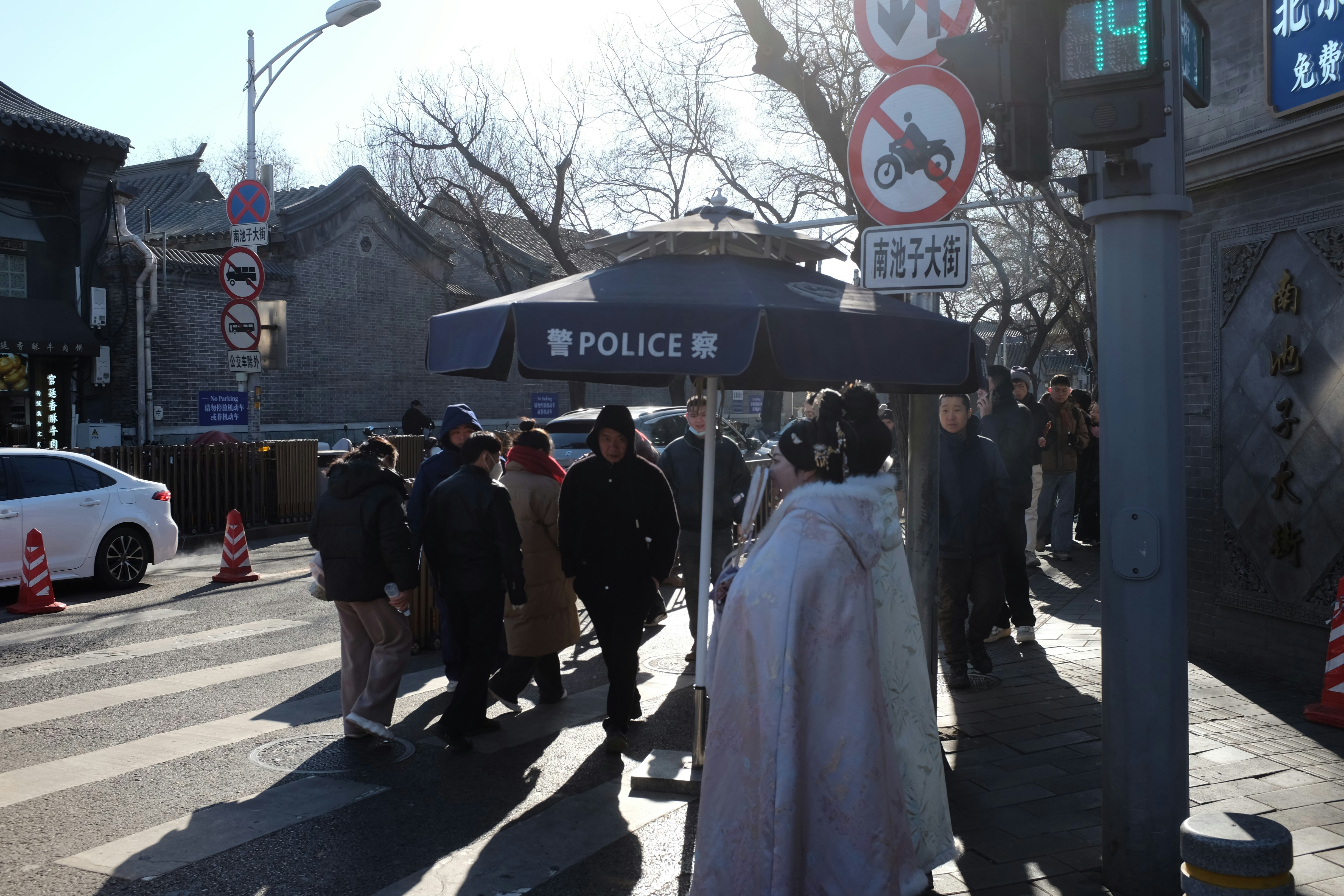Under the Police Umbrella: A Crowd at the Shaded Way