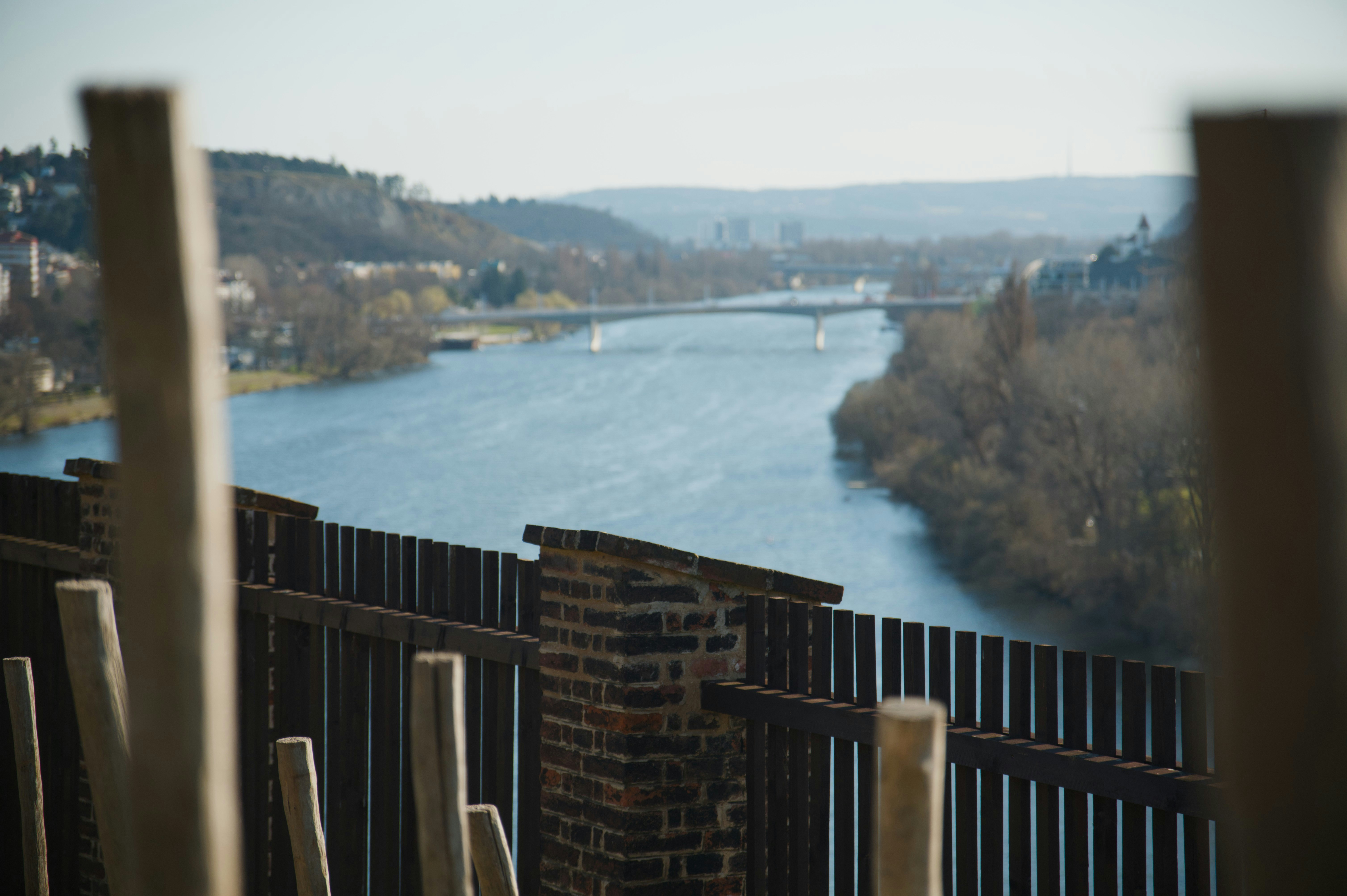 Blurred River Overlook: Fences and Bridge in Soft Focus