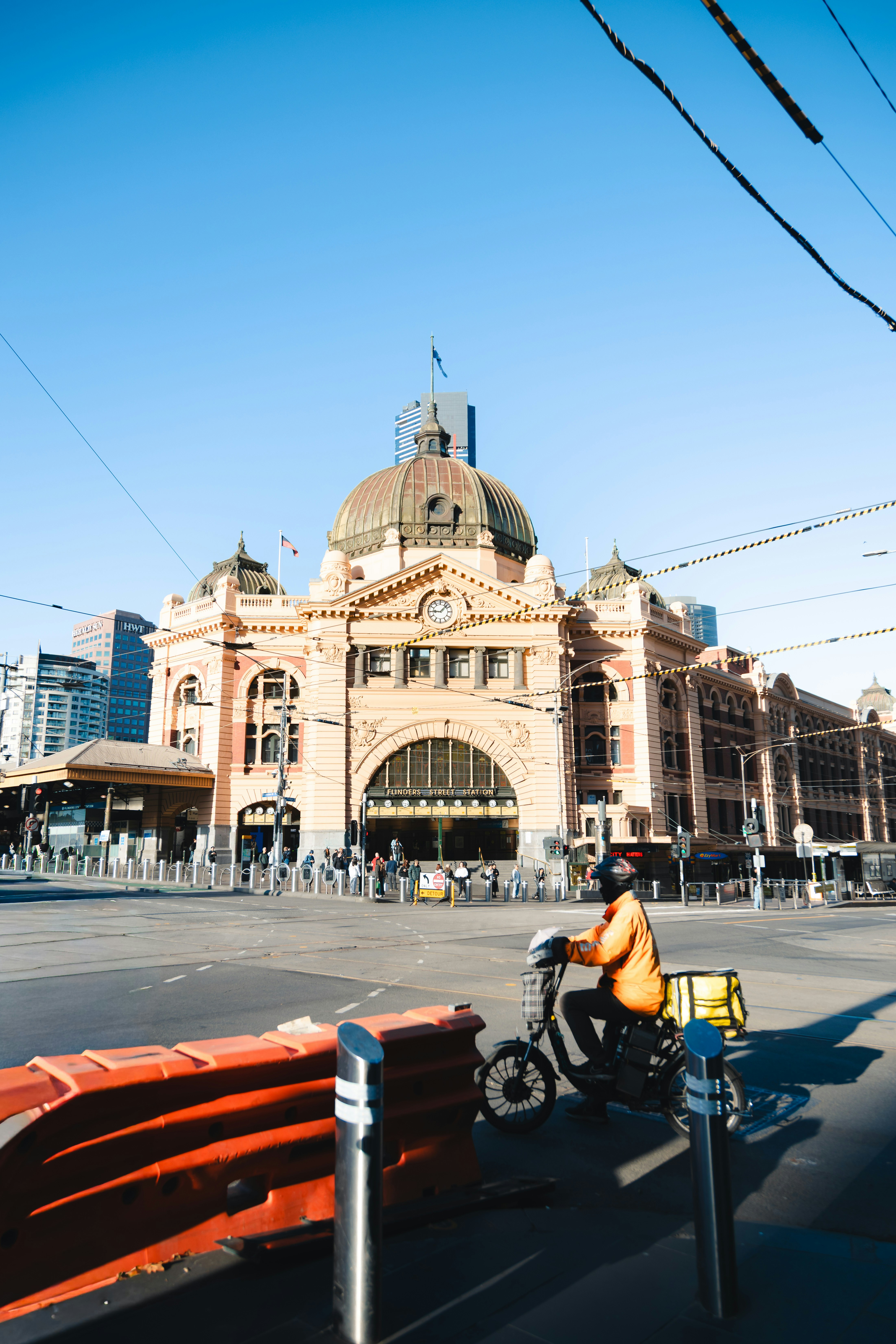 City Hall in the Light: A Bike Courier Passes the Historic Archway