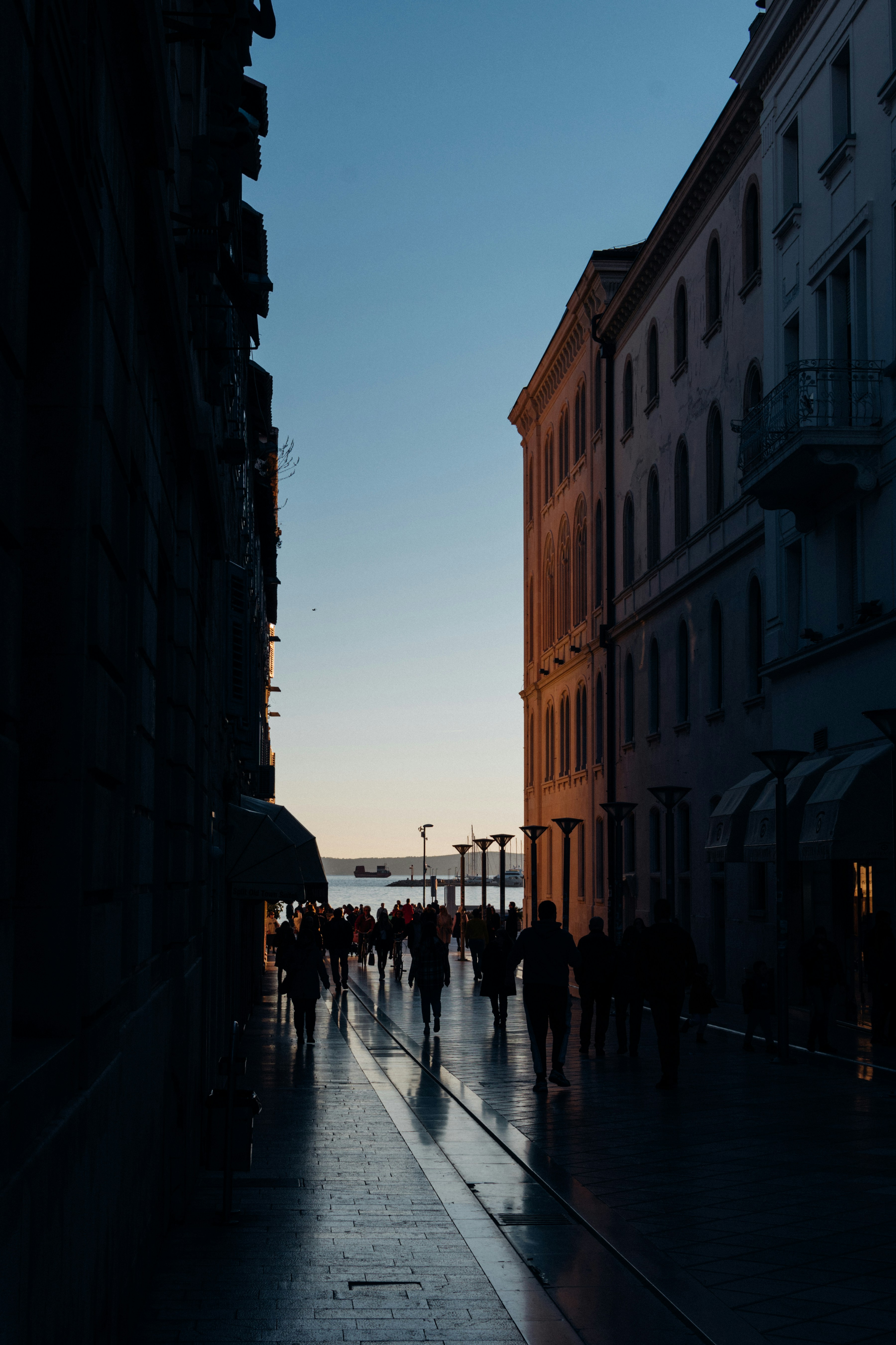 Golden Hour Promenade Between Shadowed Facades
