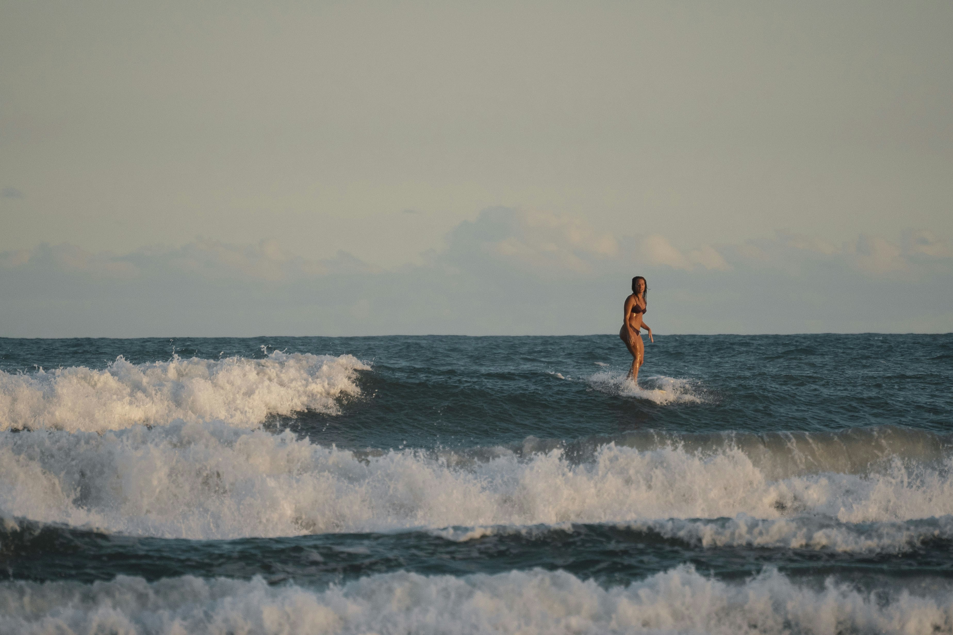 Surfer mid-glide: a lone rider carving through Atlantic swells