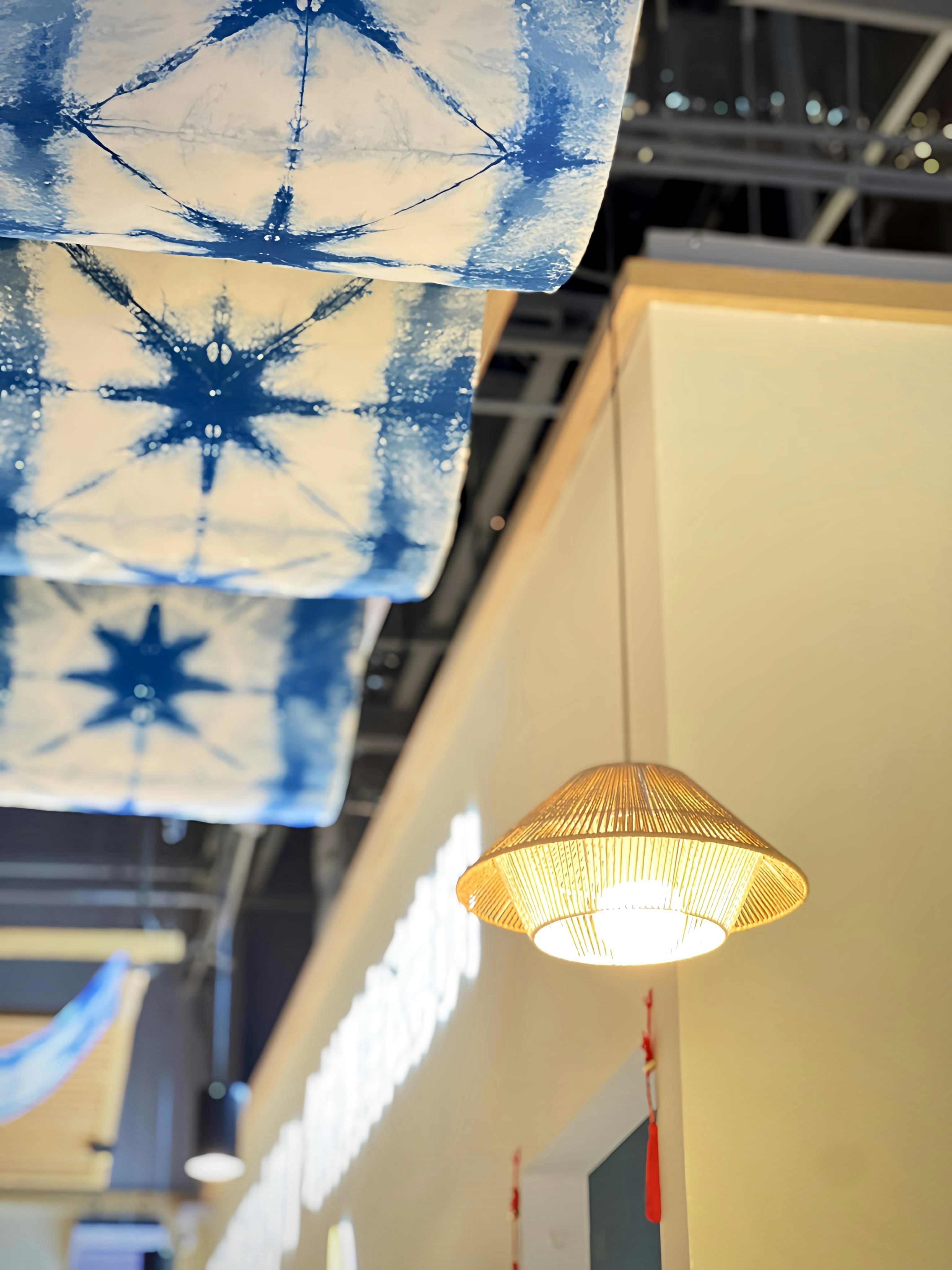 Blue-ink lanterns over a warm geometric display