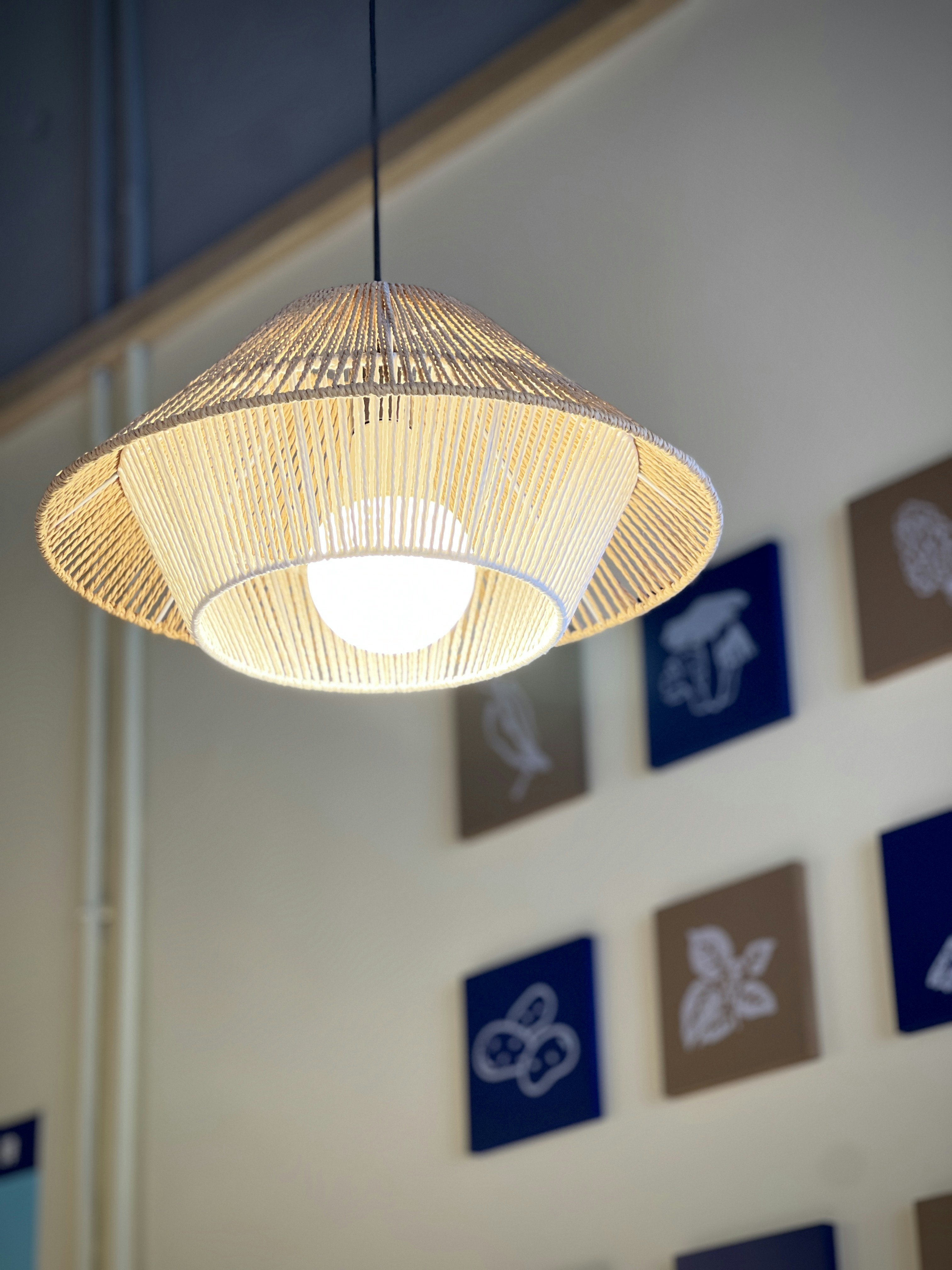 Luminous Pendant Over a Wall of Iconic Squares
