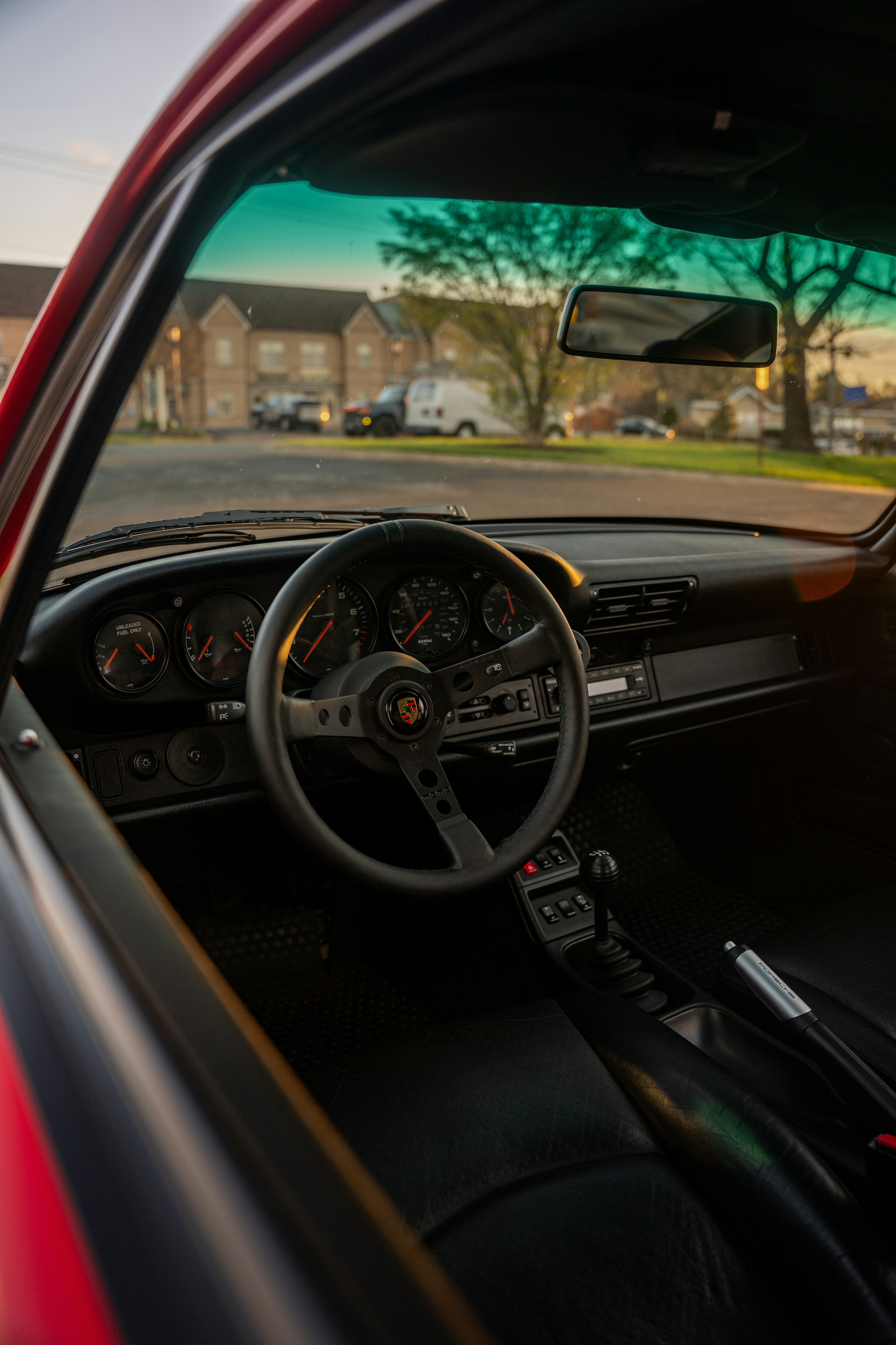 Vintage Porsche cockpit: classic gauges under soft streetlight glow