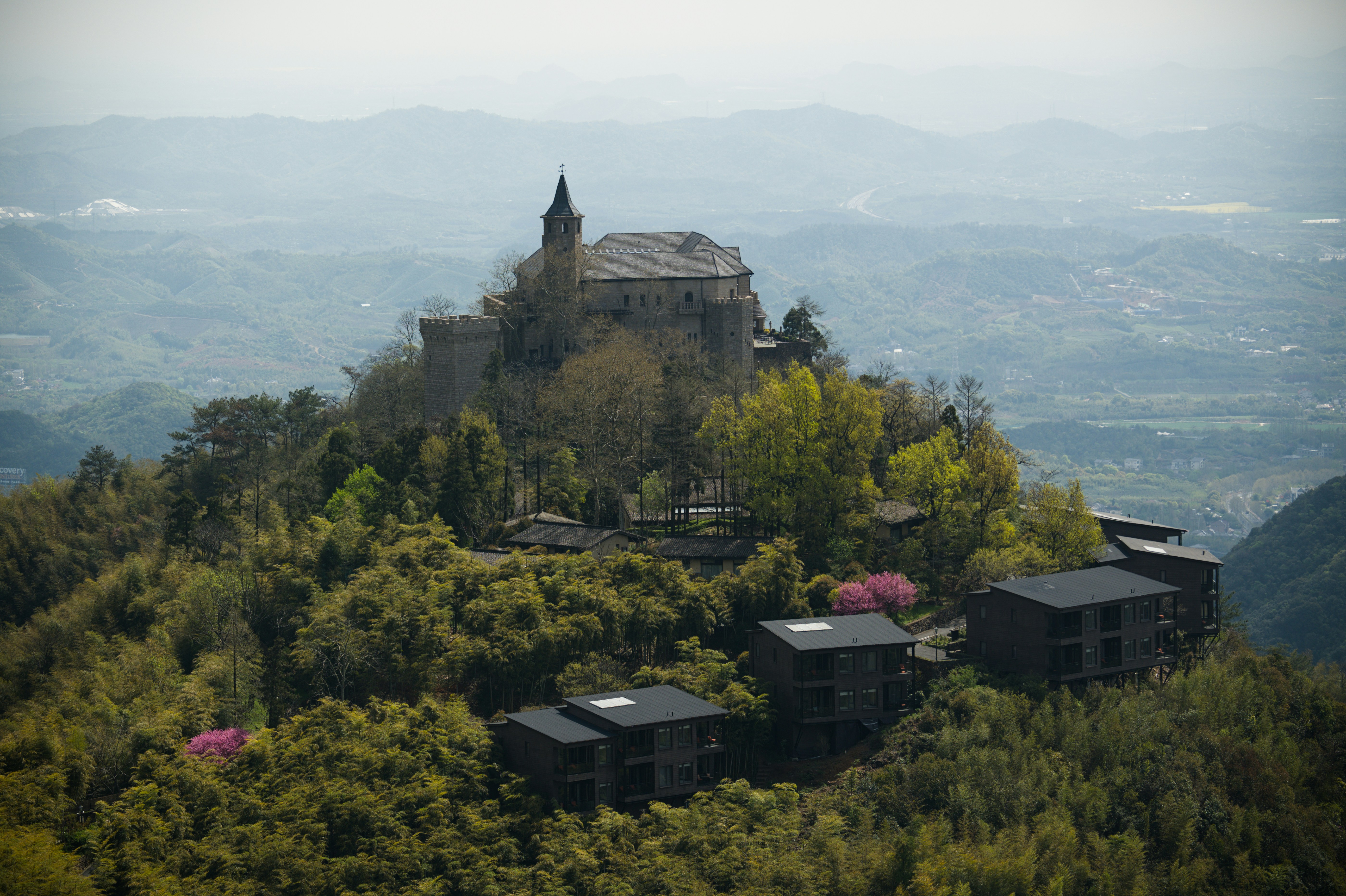 Hilltop Castle Shrouded in Mist and Spring Color