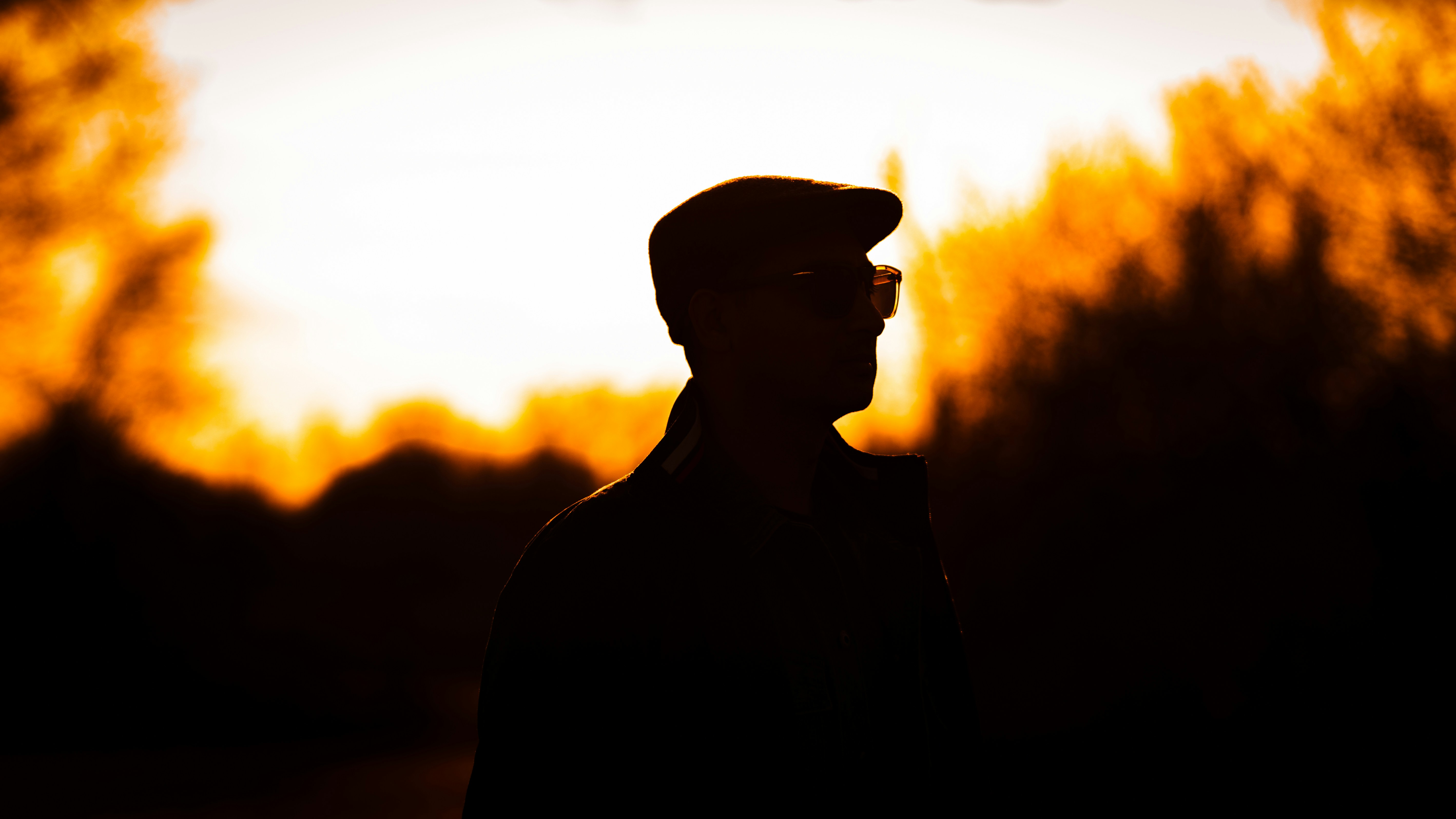 Silhouette at Sunset: A Shifted Gaze into the Warm Horizon