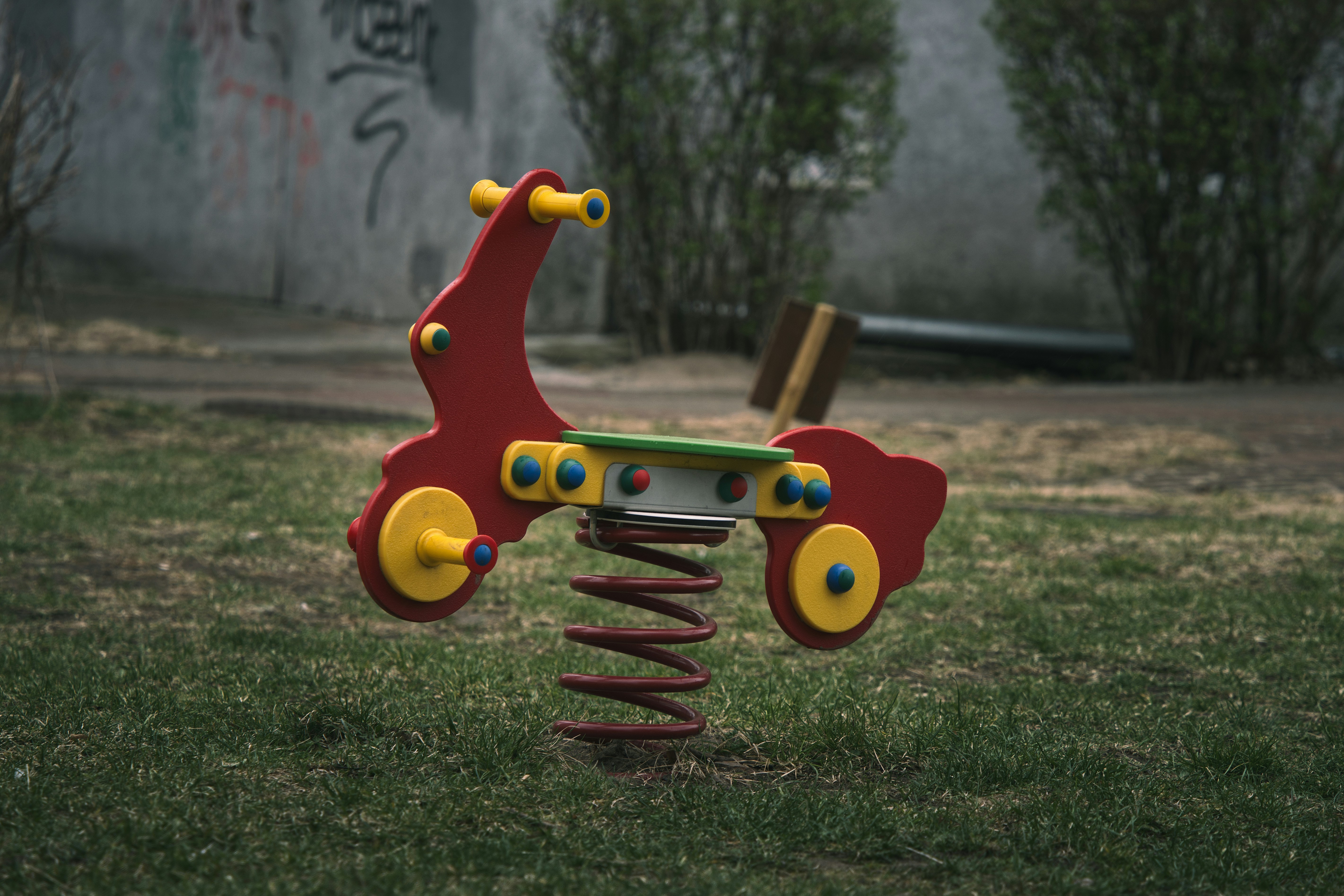 Red Spring Rider in a Quiet Playground