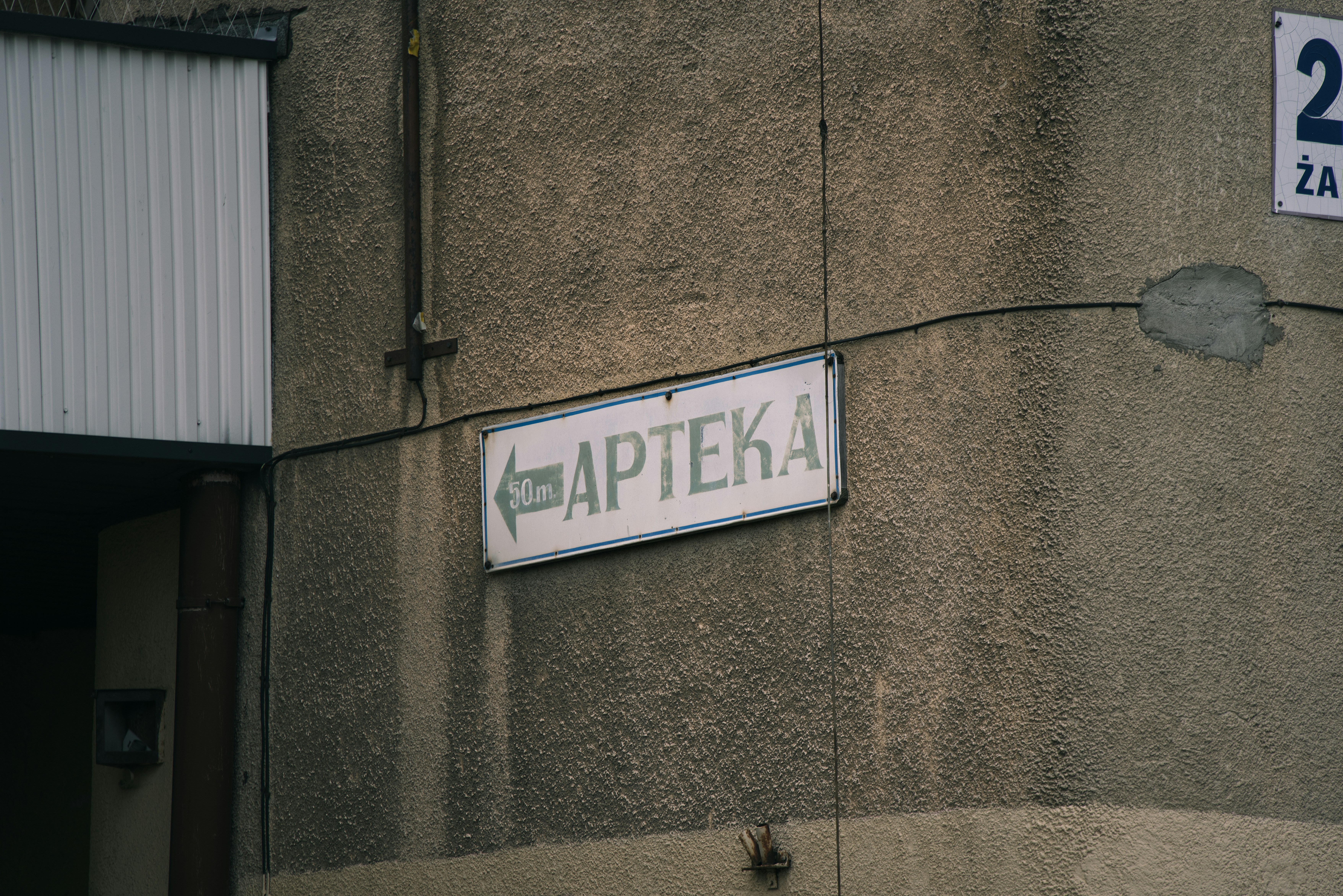 Sign on the Rough Wall: A Quiet Urban Facade