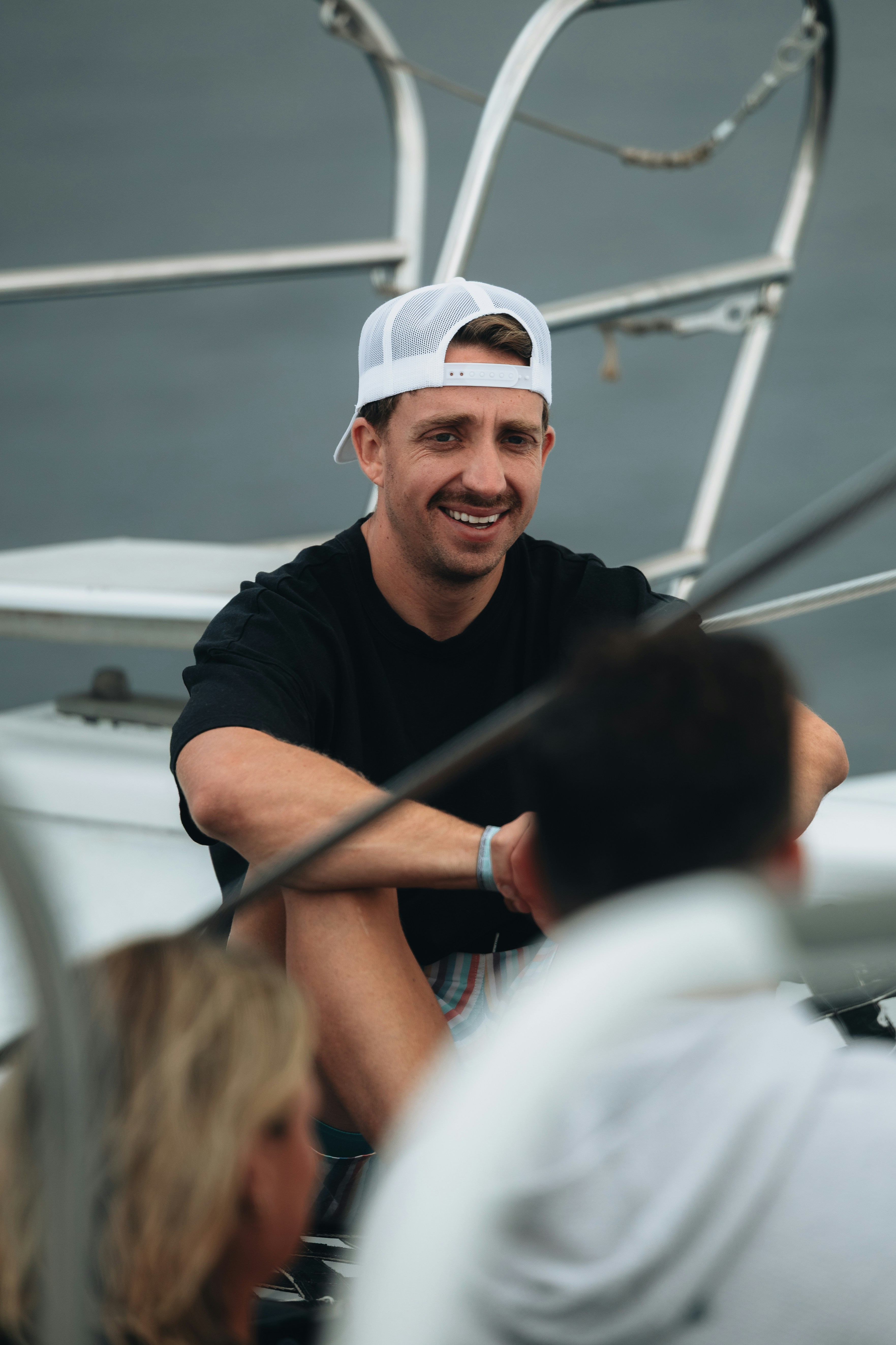 Man in hat smiling on a boat