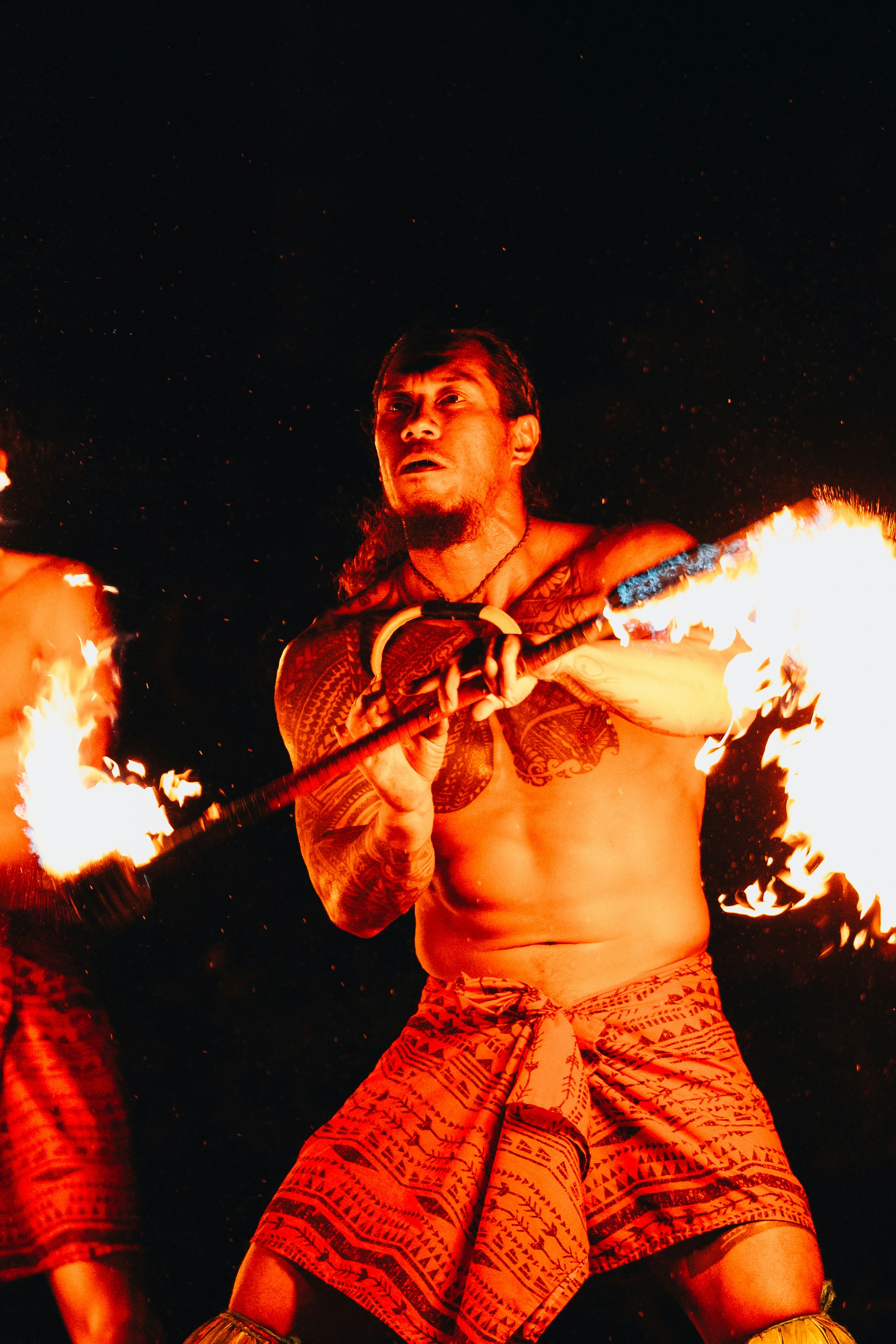 Flames in Tandem: A Fire Dancer Halts Time Mid-Spin