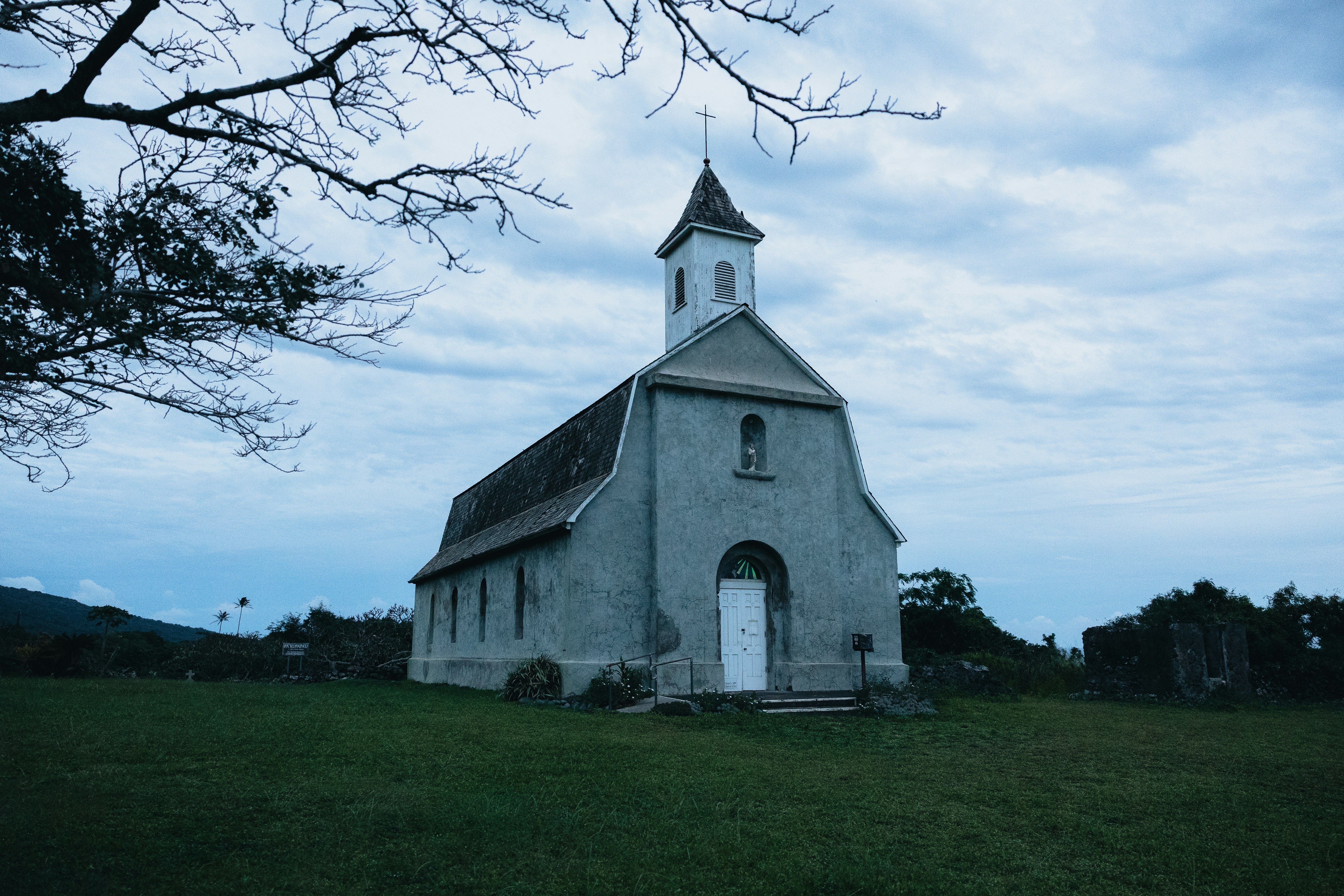 Quiet Chapel Amid Open Field under Subtle Clouds
