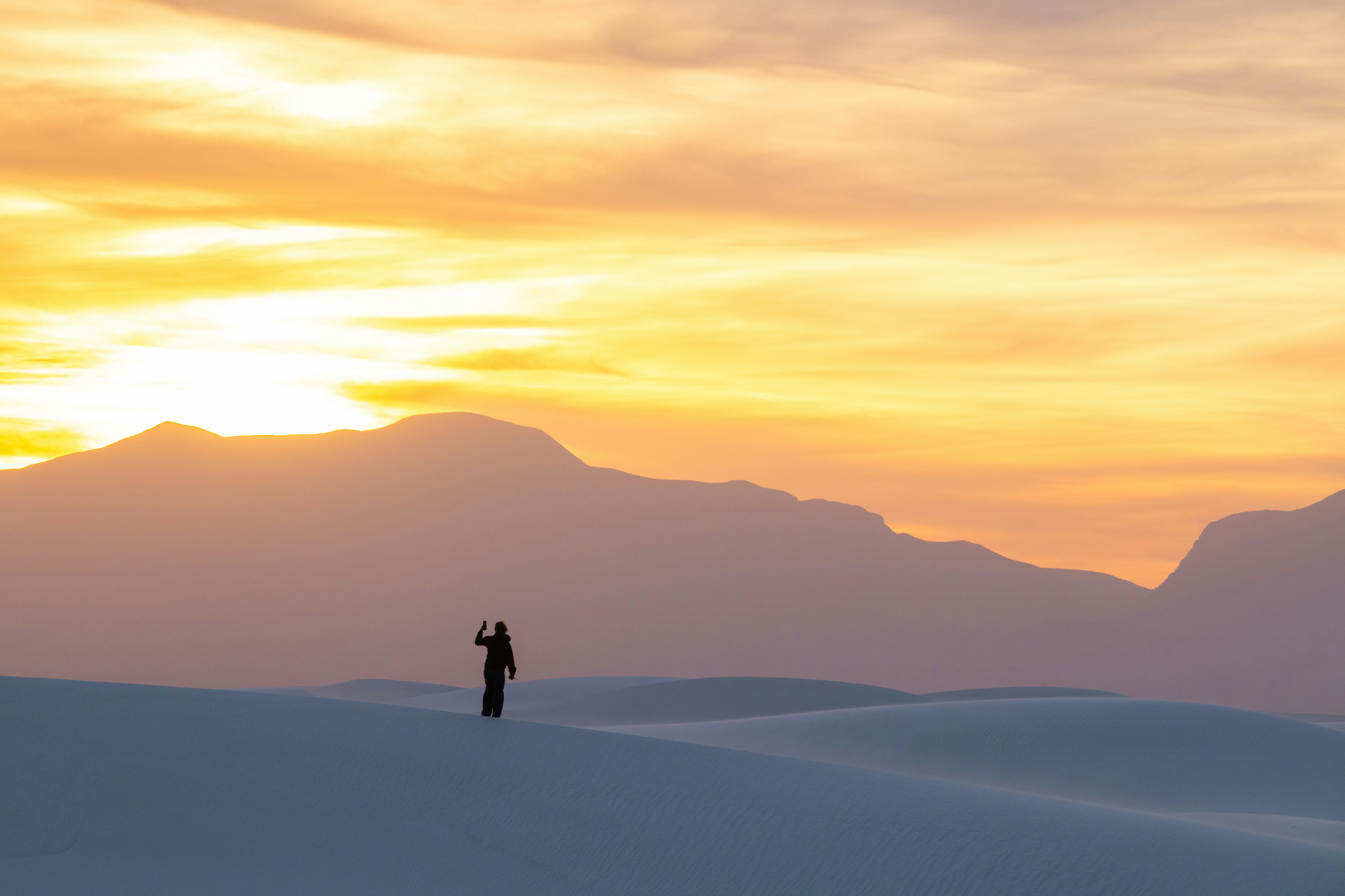 Silhouette at Dusk: Lone Traveler on Dusky Dunes