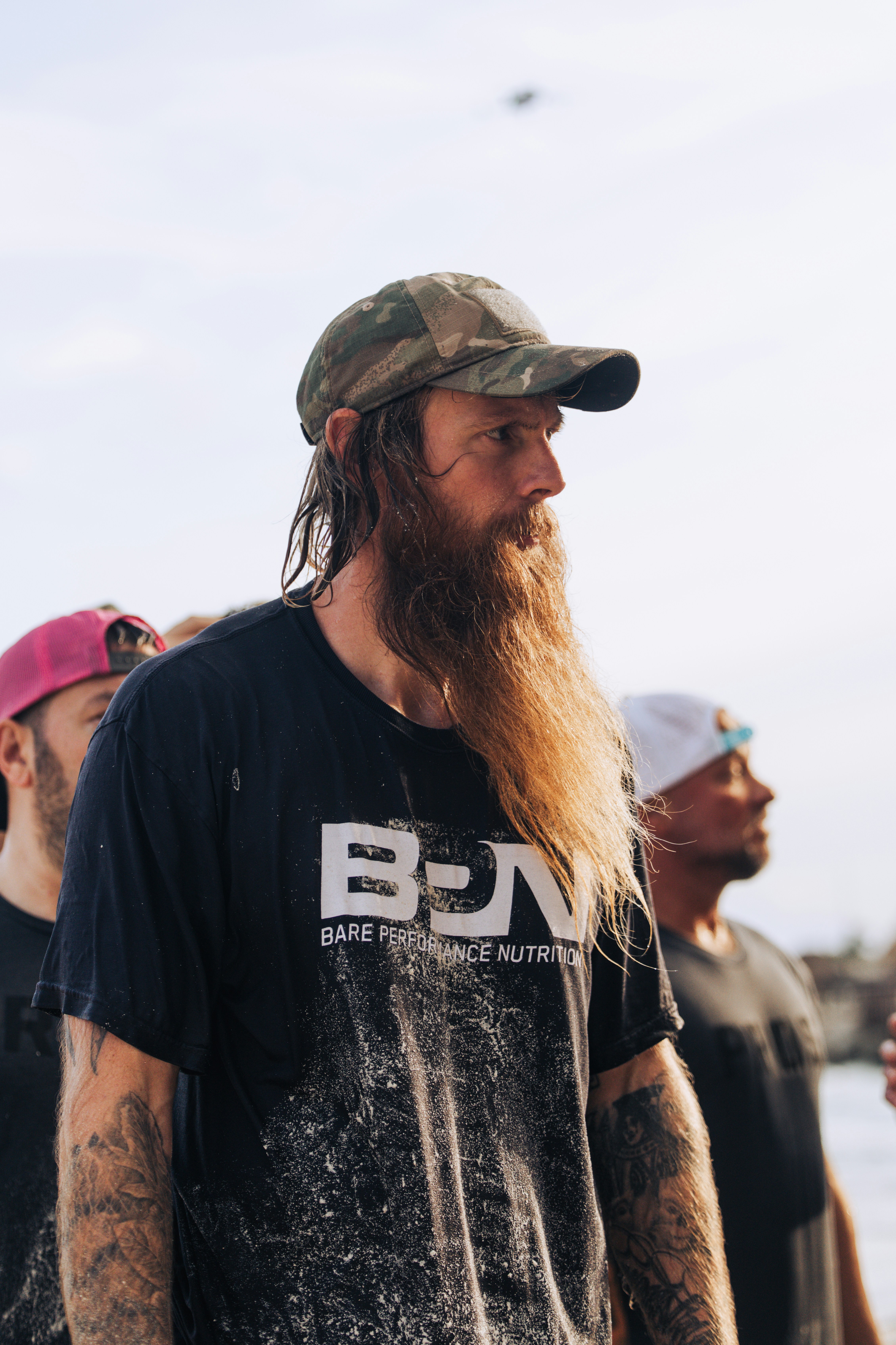 Bearded Grit: A Solo Moment Amid a Rowdy Crew