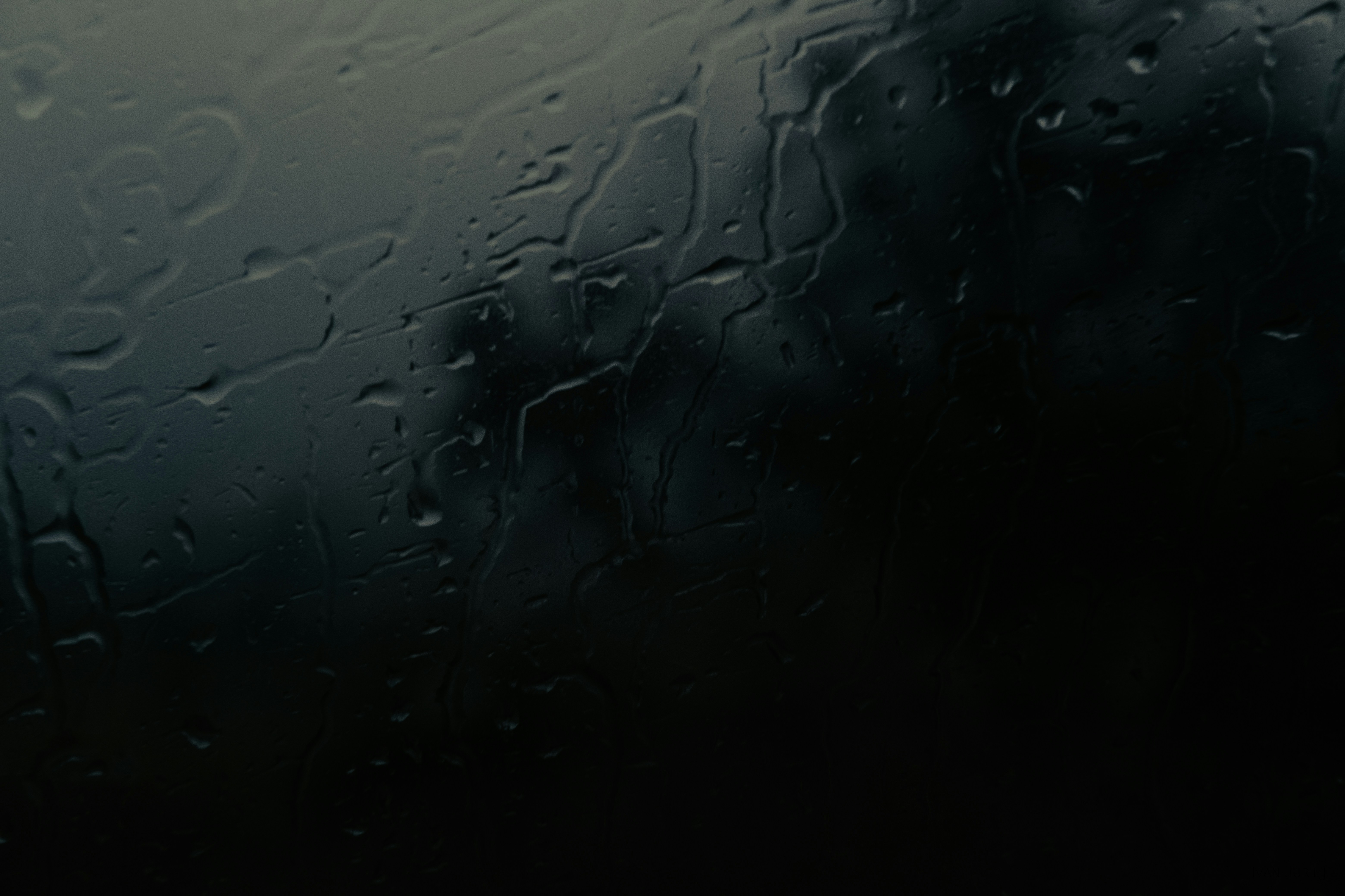 Dim Rain on Glass: Abstract Texture of Droplets in Low Light