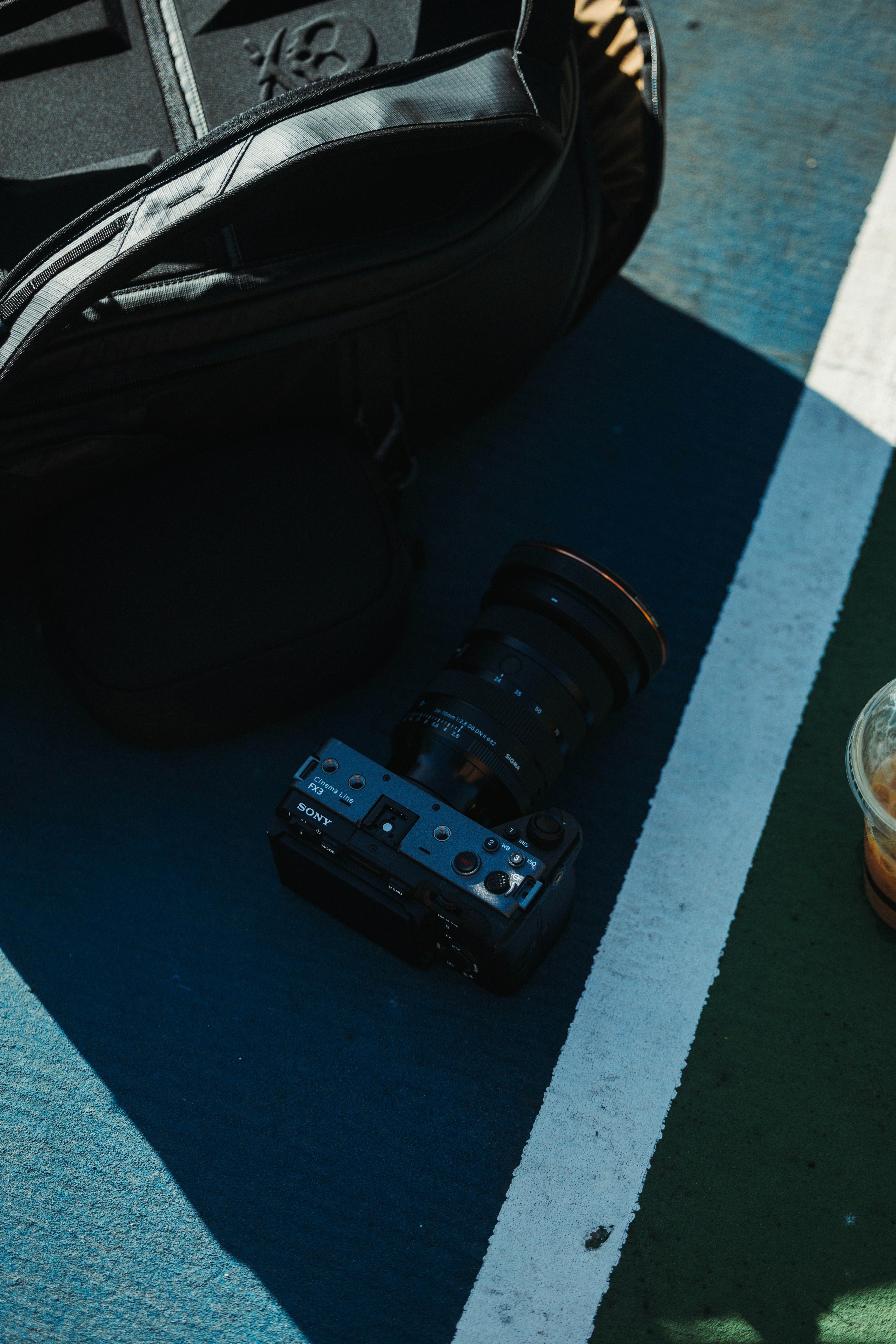 Low-Angle Studio Moment: A Sony Sony? No—just a compact mirrorless on the blue court
