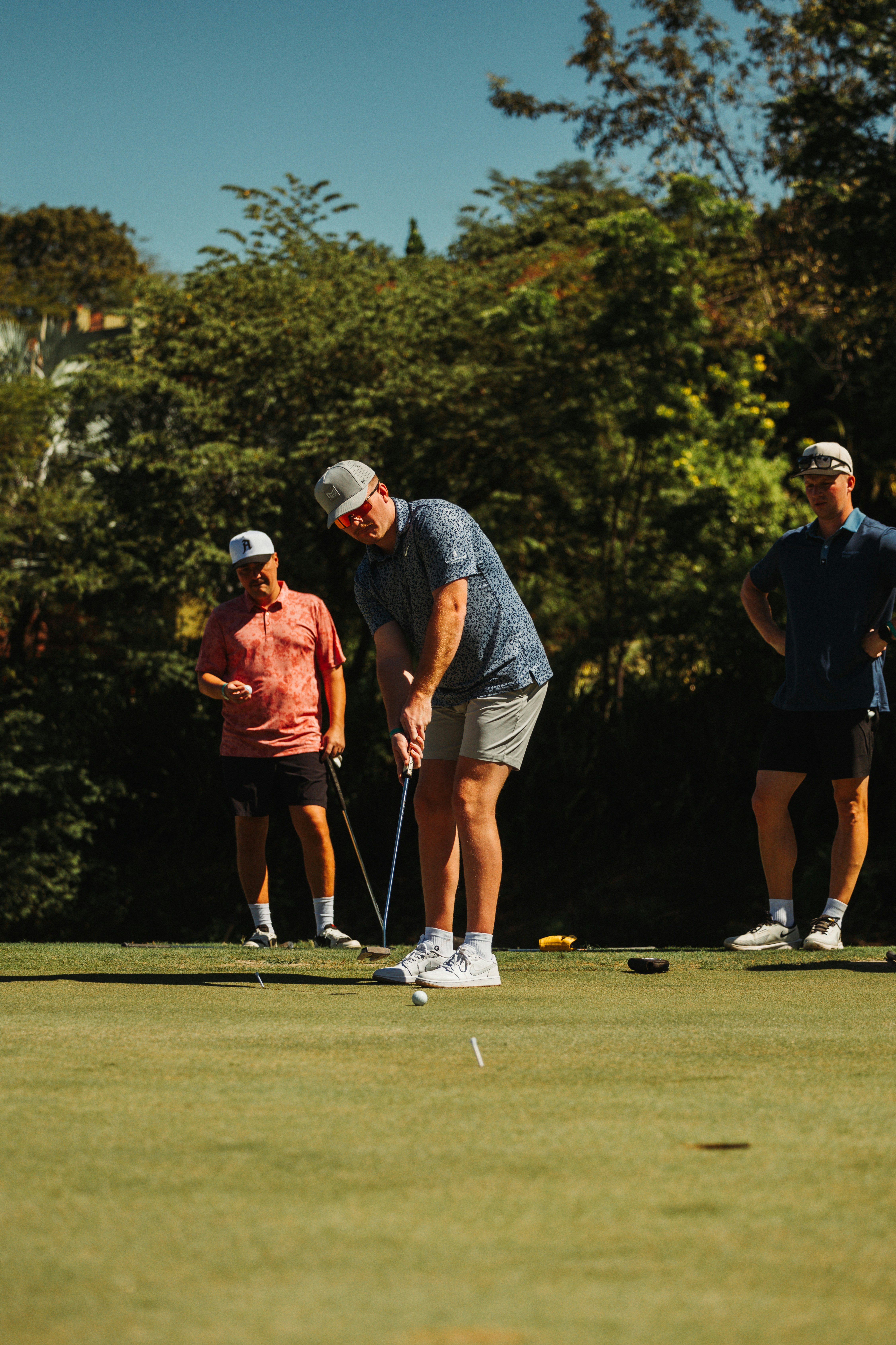 Center Cut on the Tee: Focused Swing Amid Greenery