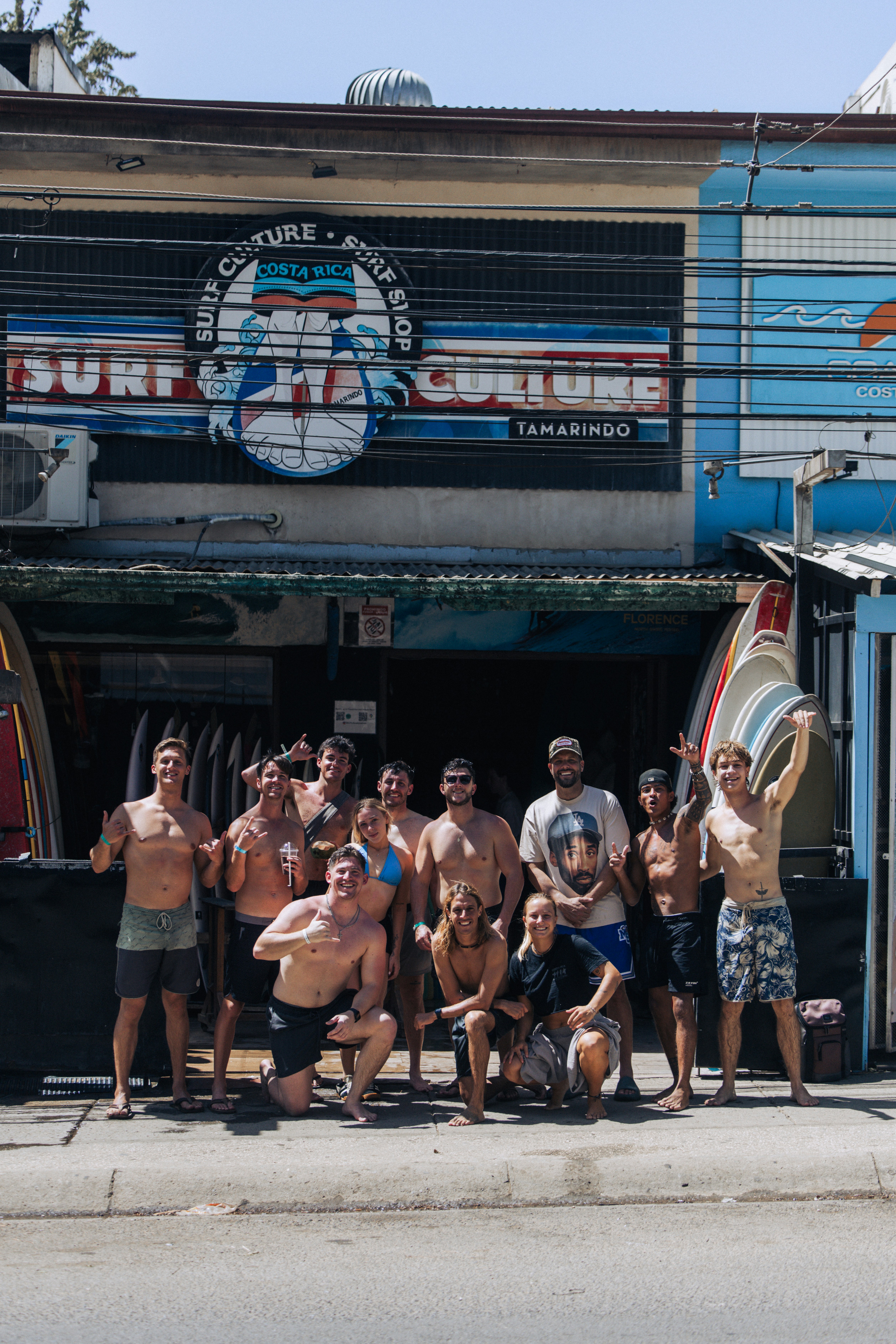 Surf Culture Crew posing outside a beachside shop campaign
