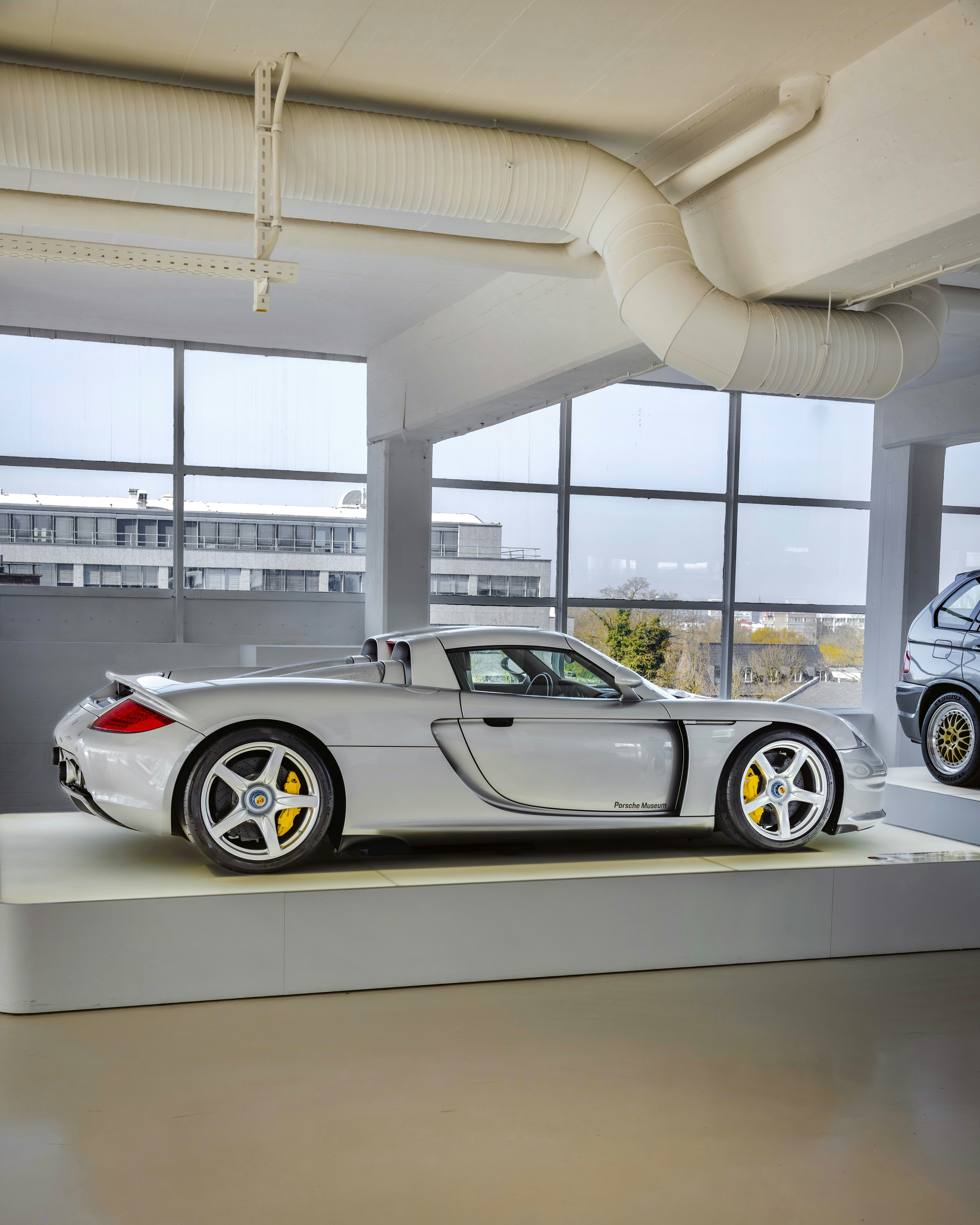 Silver Porsche Spyder on a Minimalist Car Display