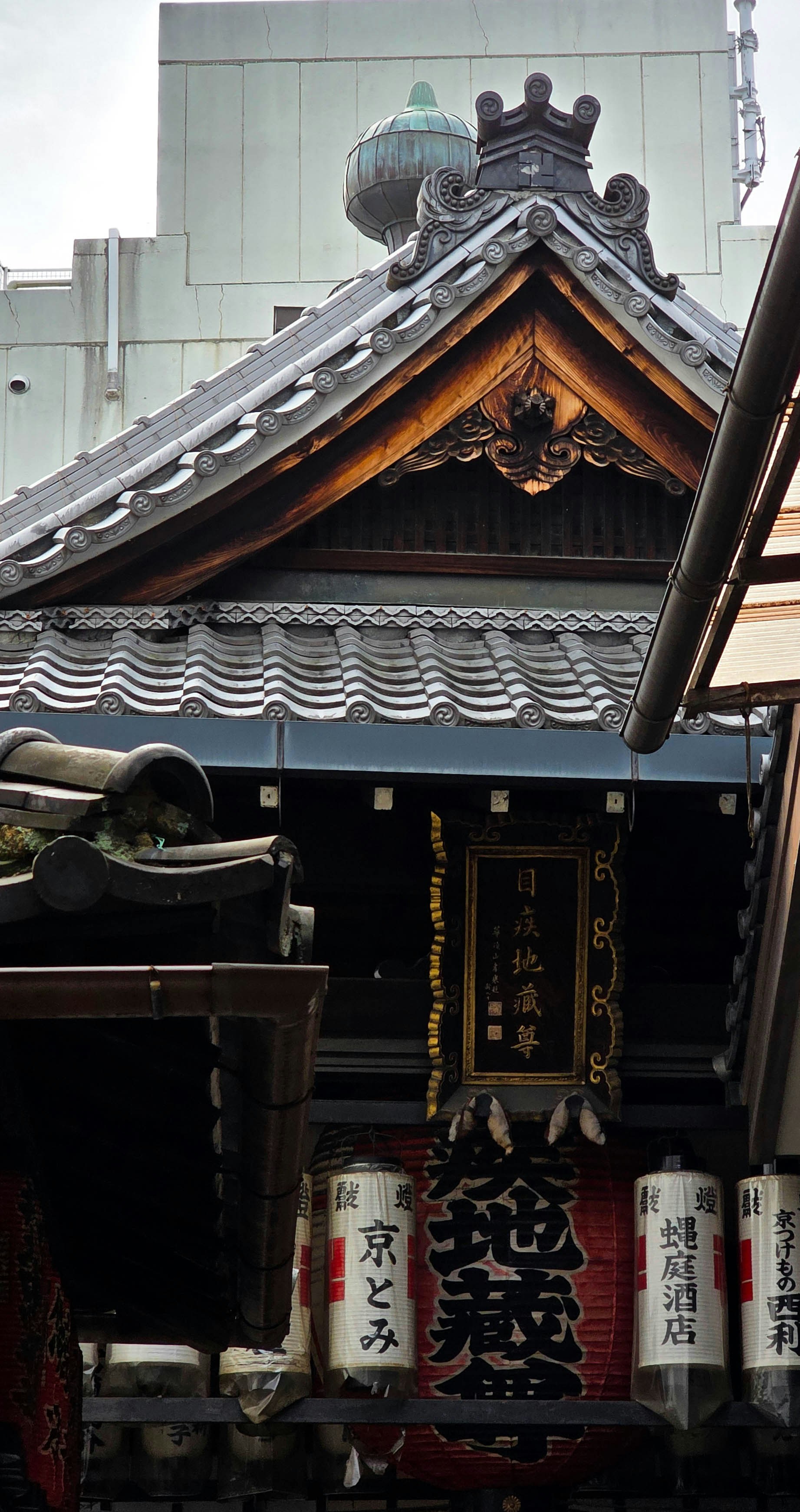 Temple Decor on a Narrow Alley: Carved Roofline and Lanterns
