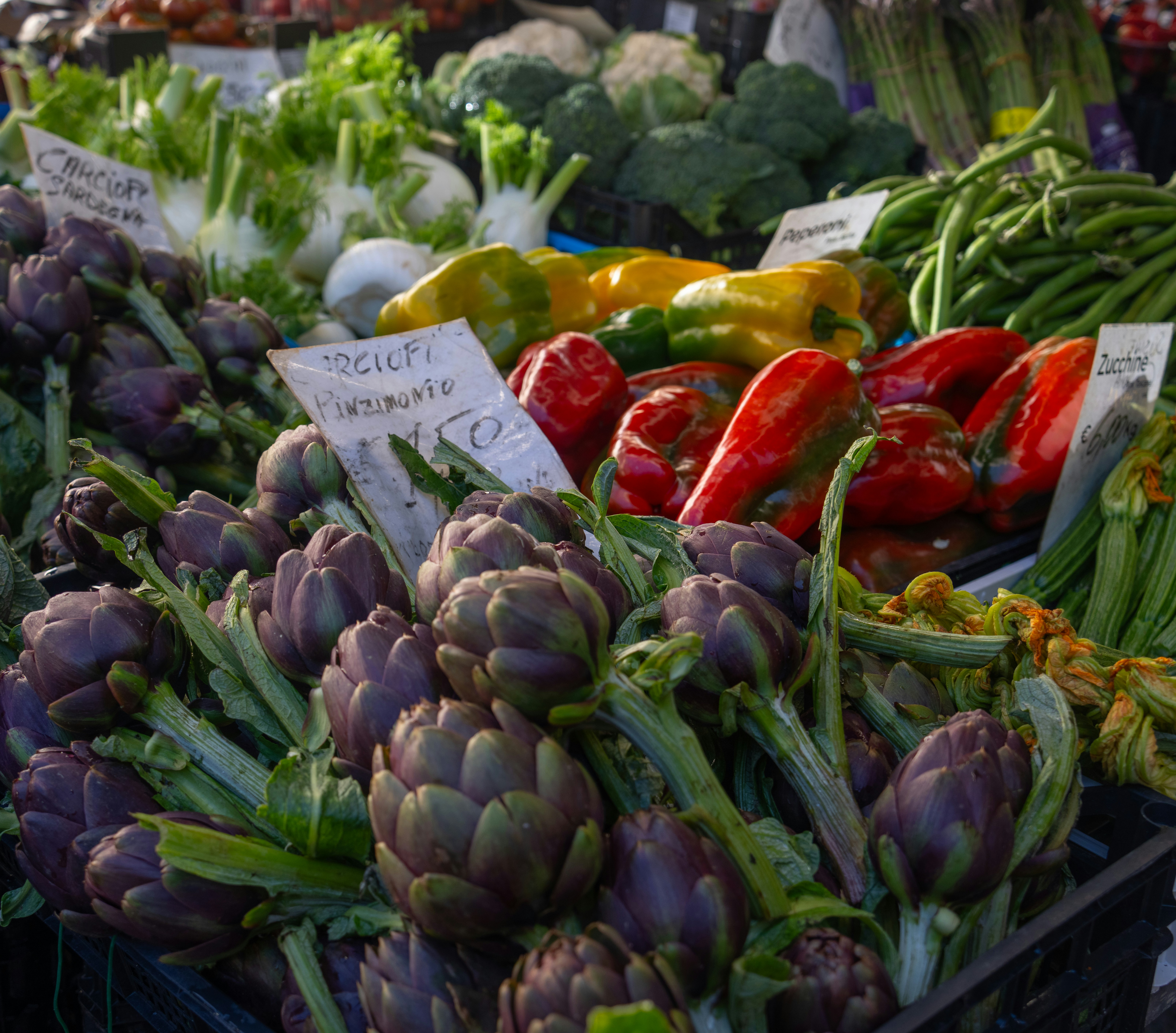 Purple Artichokes at a Bustling Market Stand