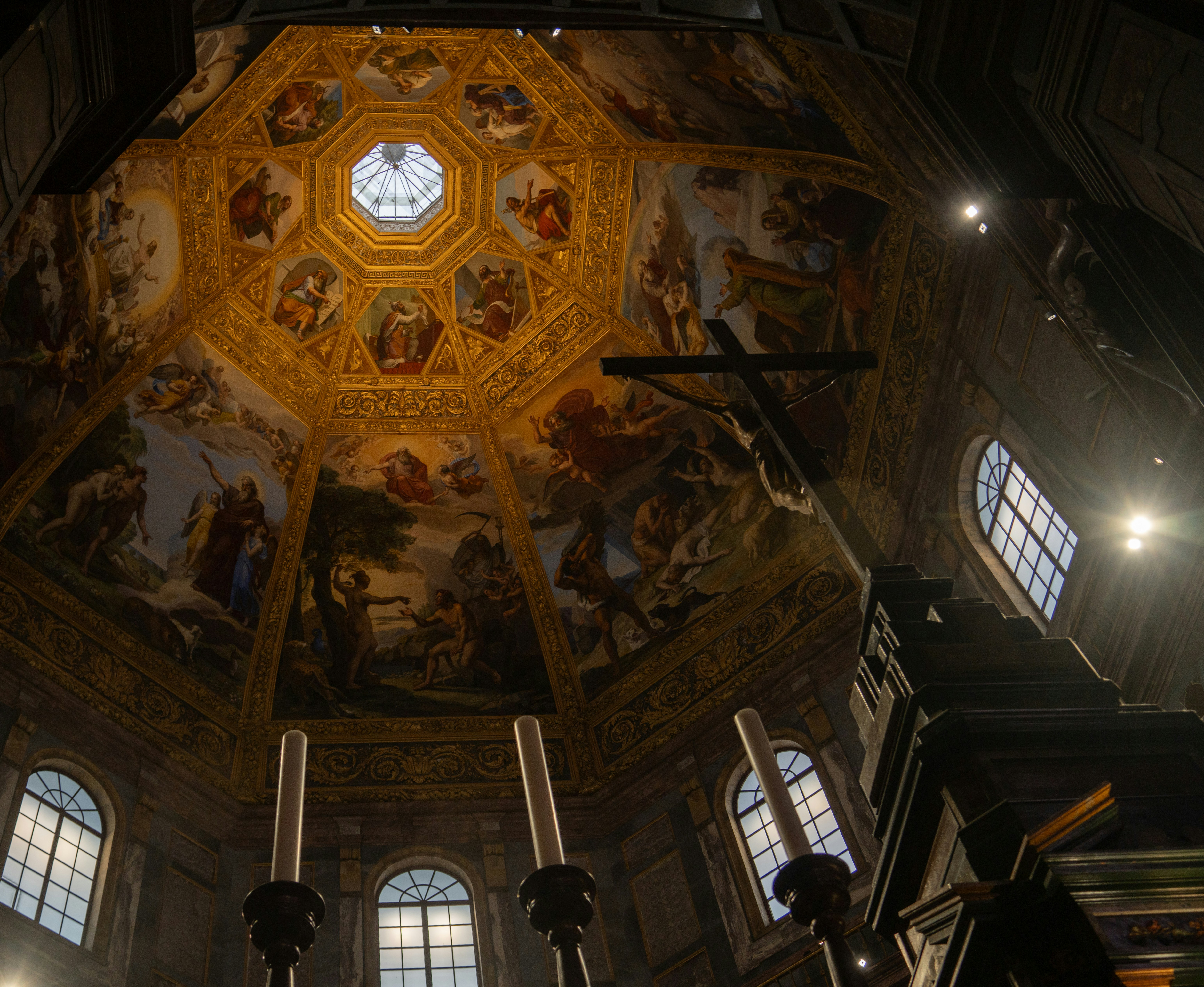 Vaulted Masterpiece: Sunlit Dome Amidst Dim Nave