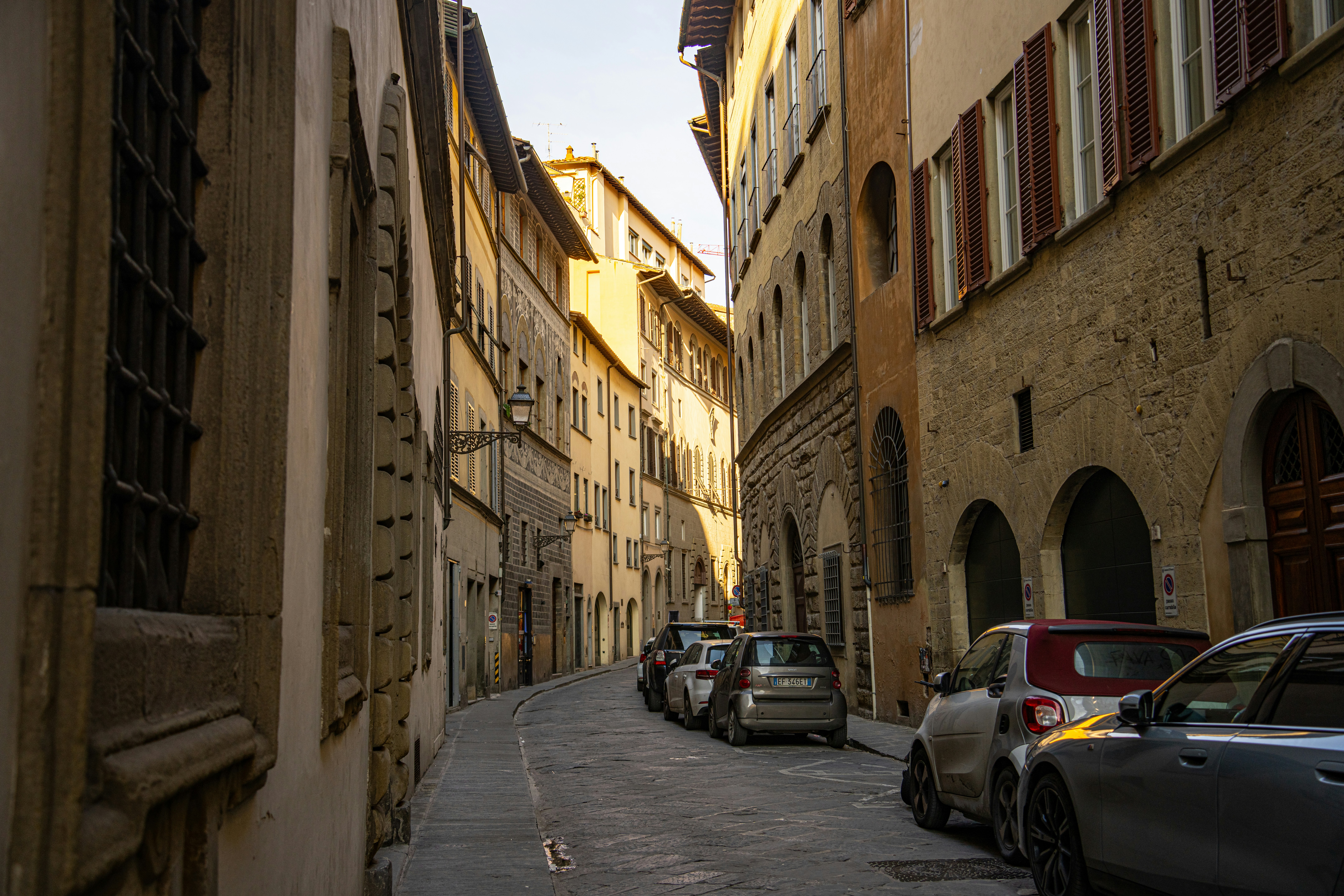 Sunlit Alleyway Between Historic Facades