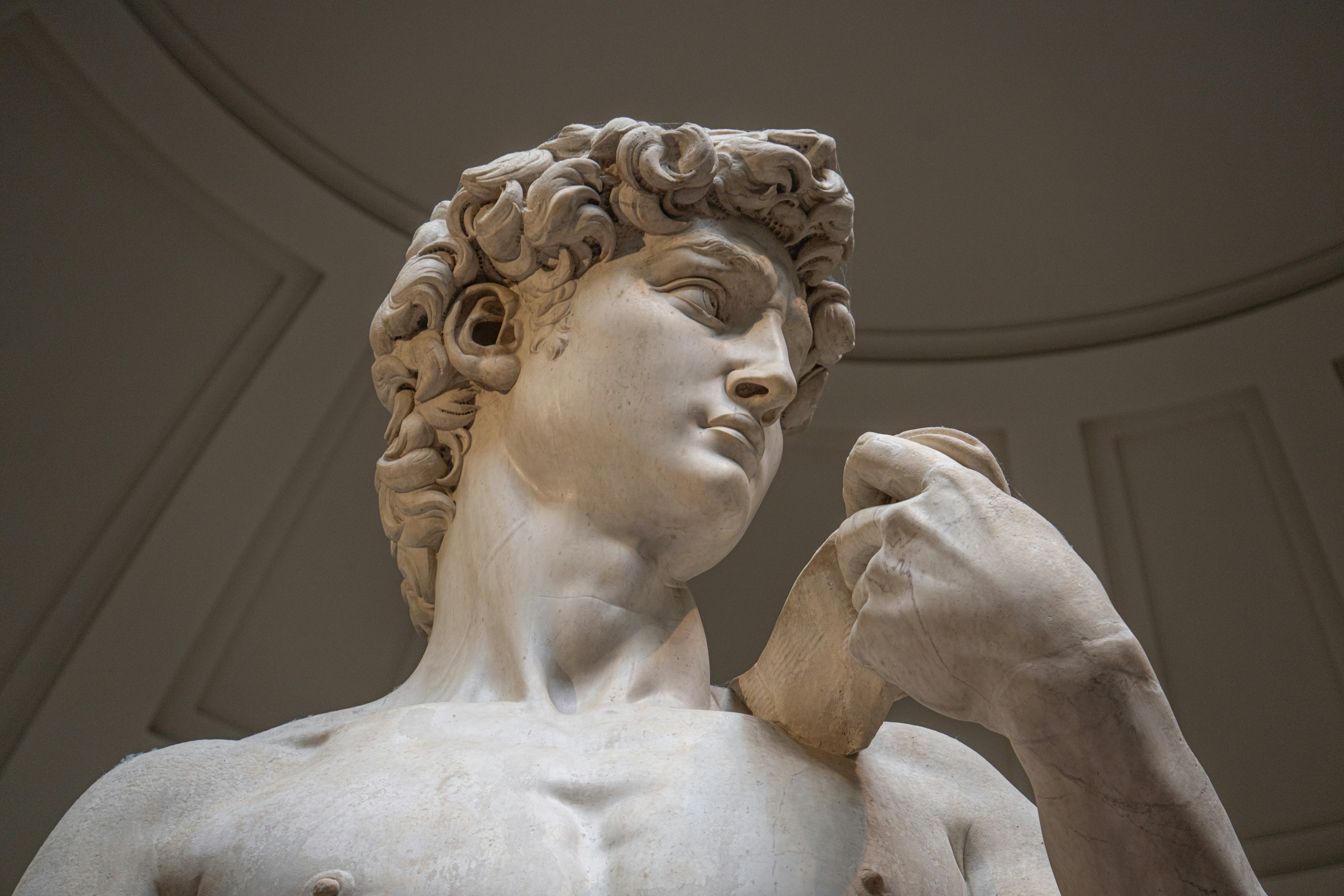 Whisper of Marble: A Stoic Gaze Beneath Draped Light