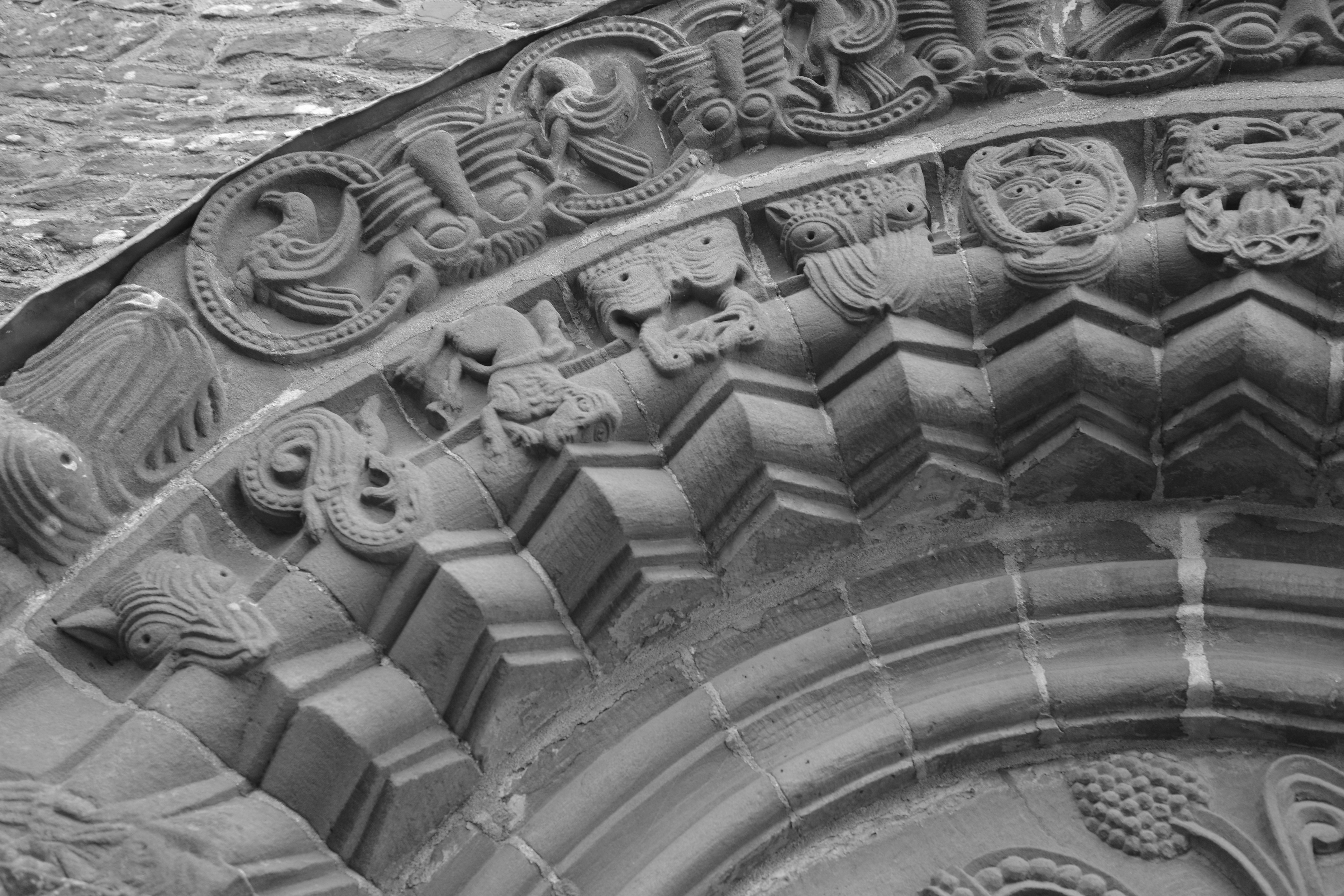 Carved Arch Ring: Ancient Stone Detail in Monochrome