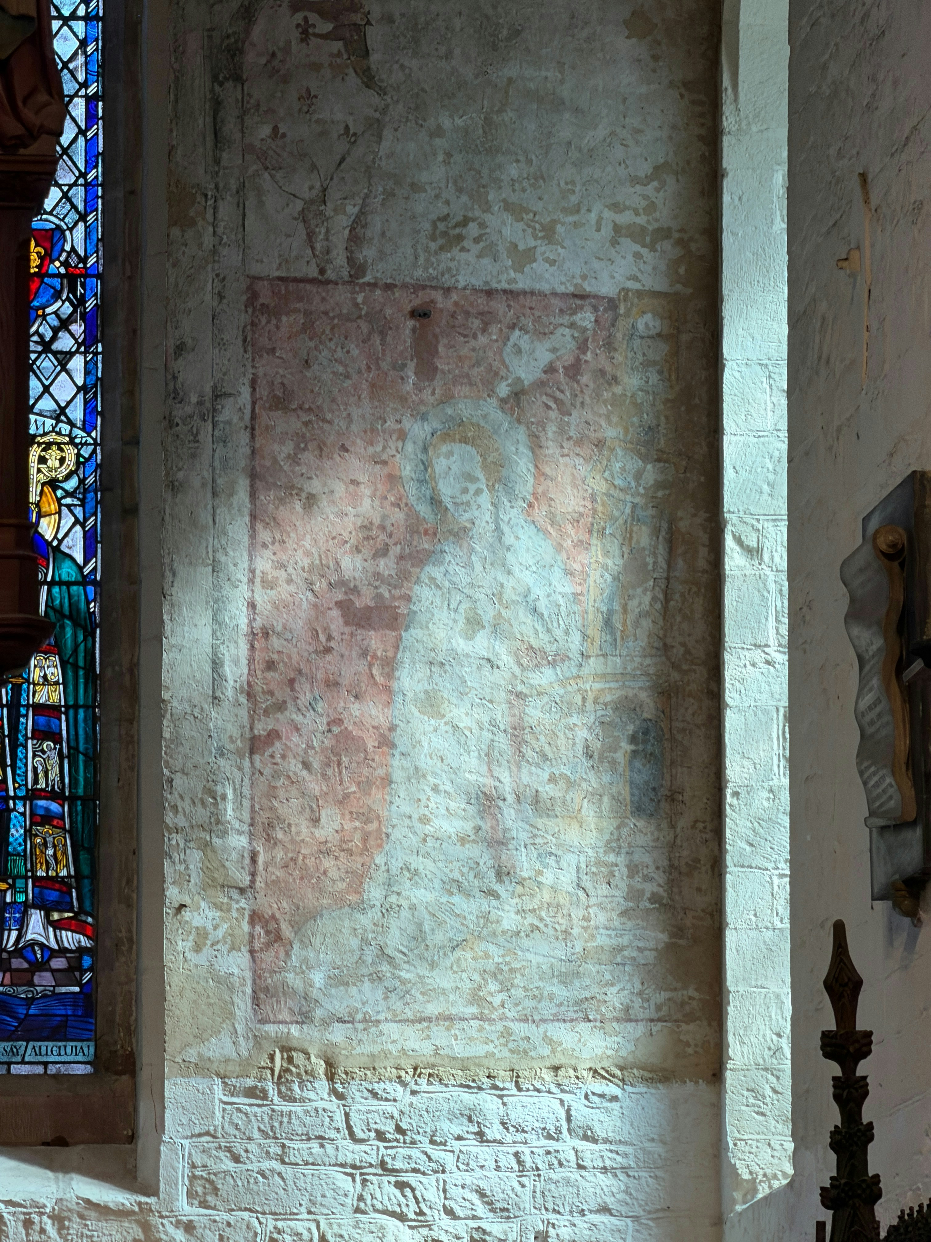 Faded Halo: A Ghostly Christ Icon on Weathered Wall