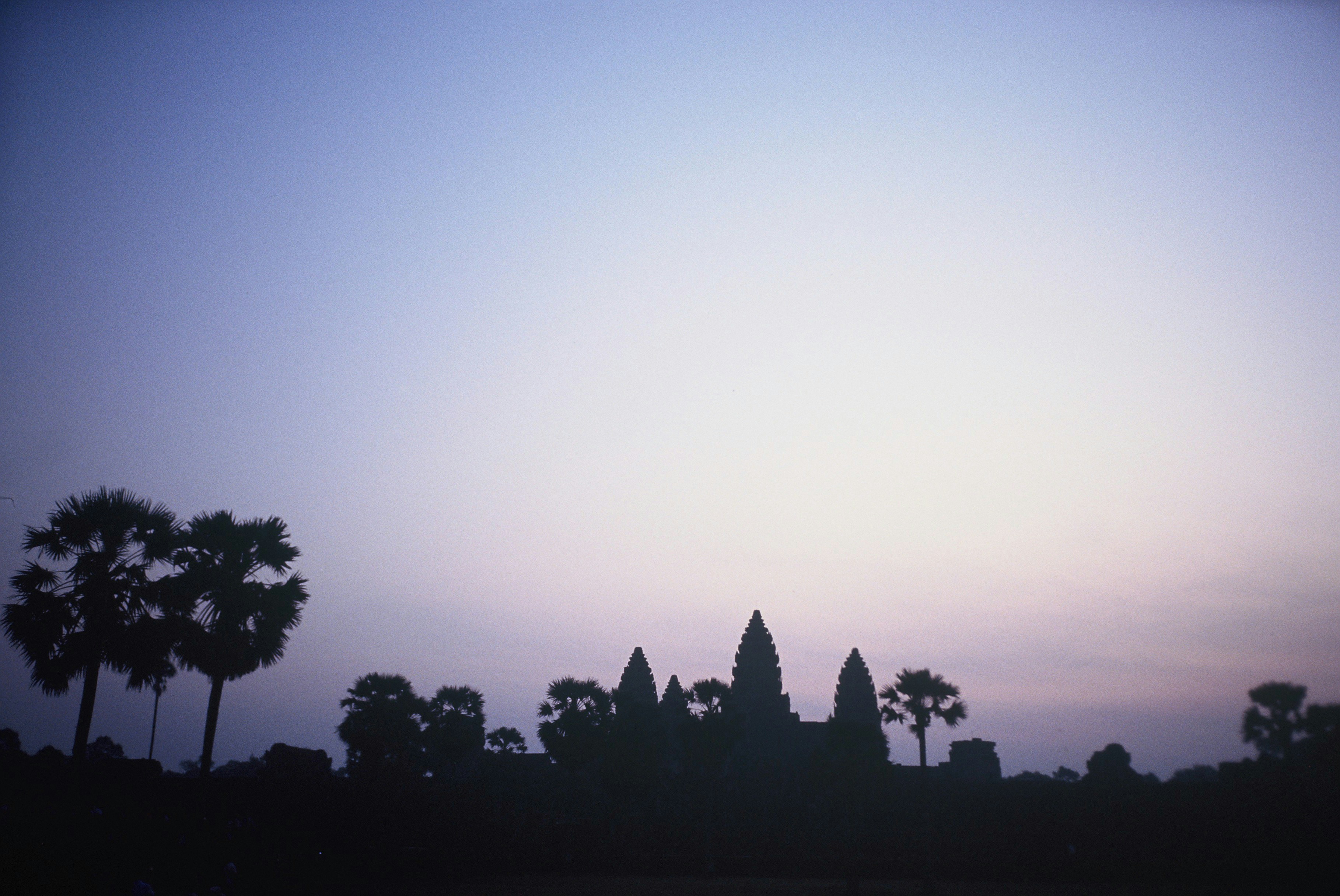 Distant silhouettes beneath a fading twilight sky