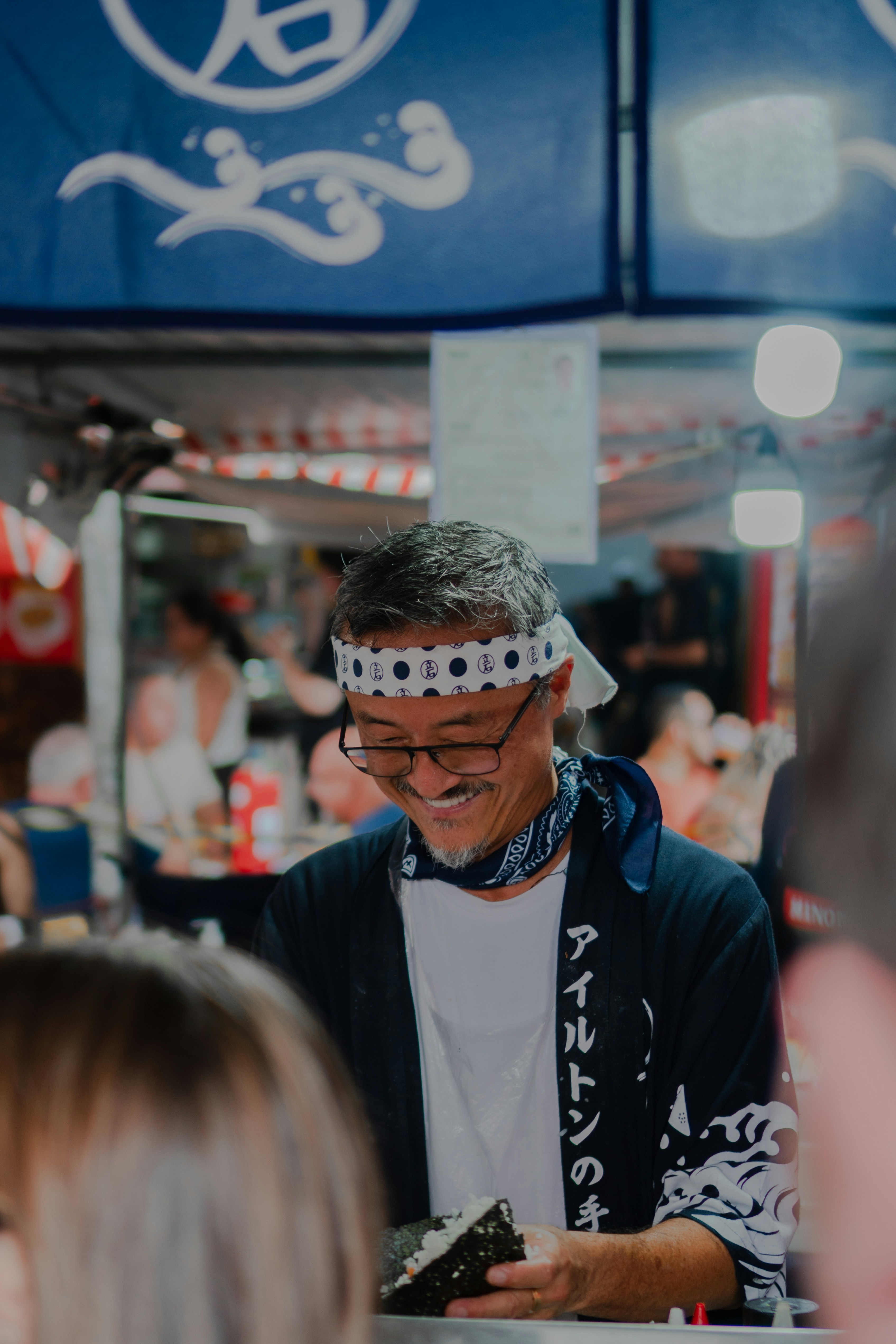 Market Vendor's Quiet Joy: A Moment of Craft in Focus