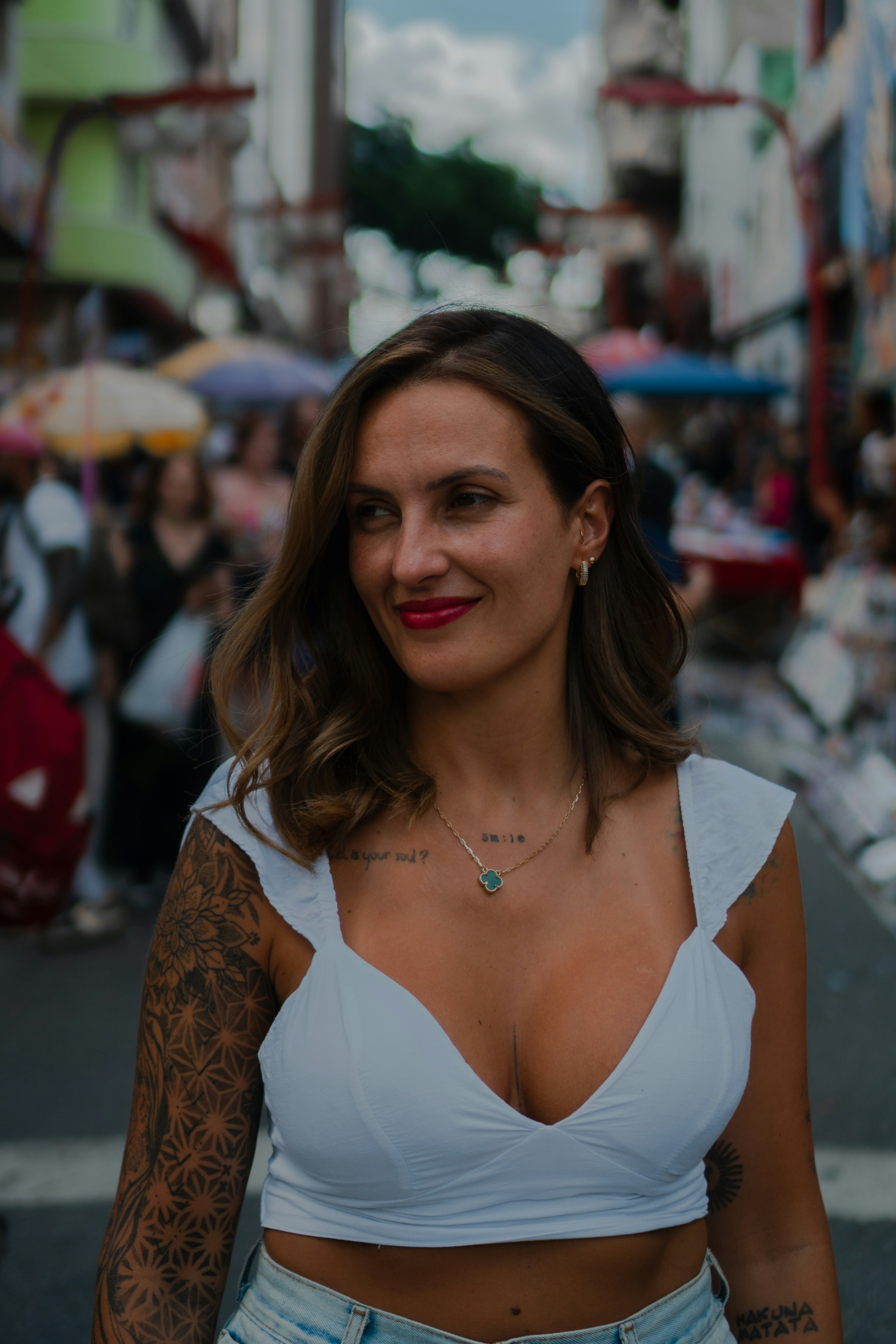 Street-side Portrait: A Confident Smile Amid a Bustling Market