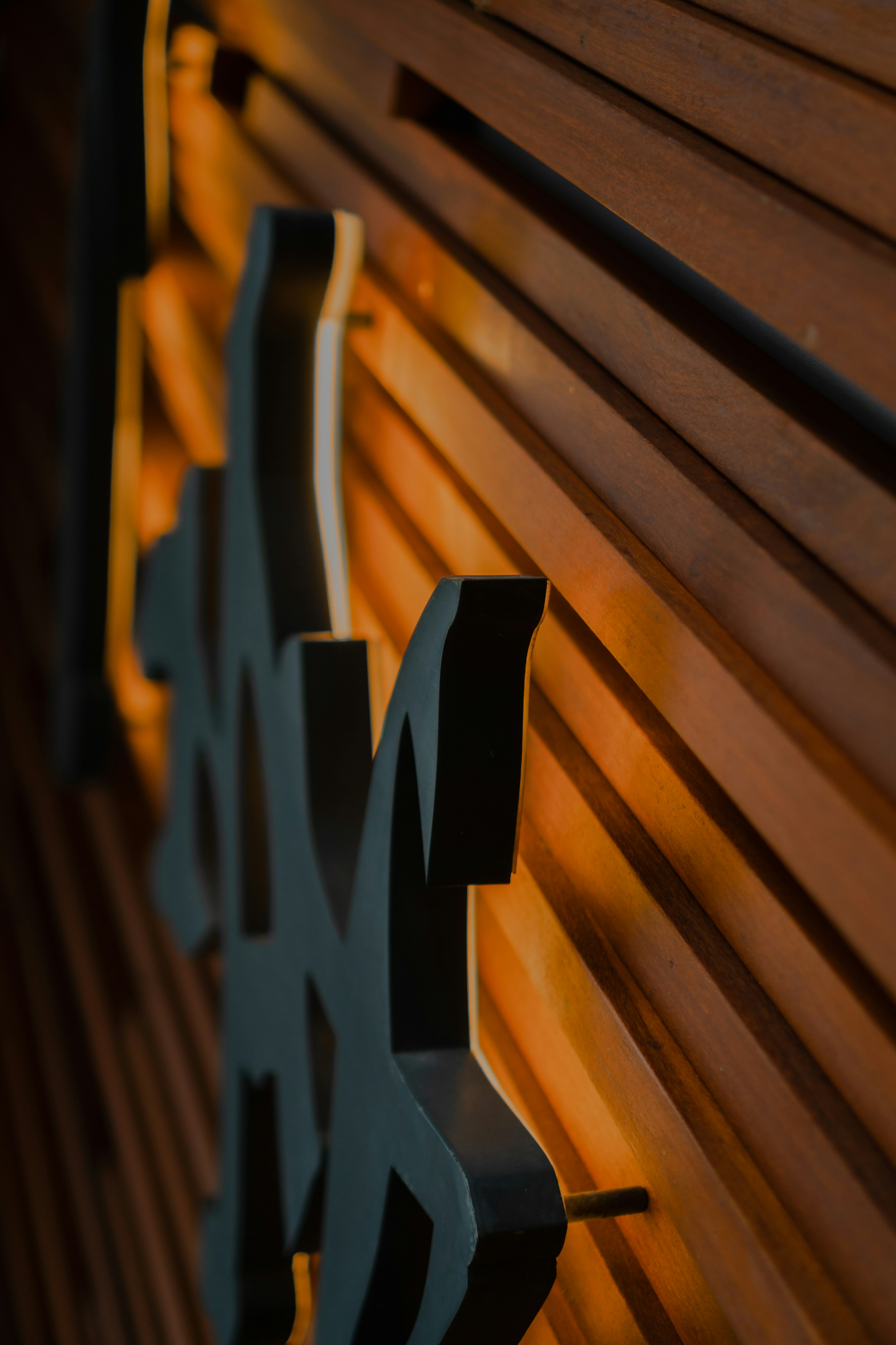 Backlit Wooden Graffiti: Architectural Letters in Warm Glow
