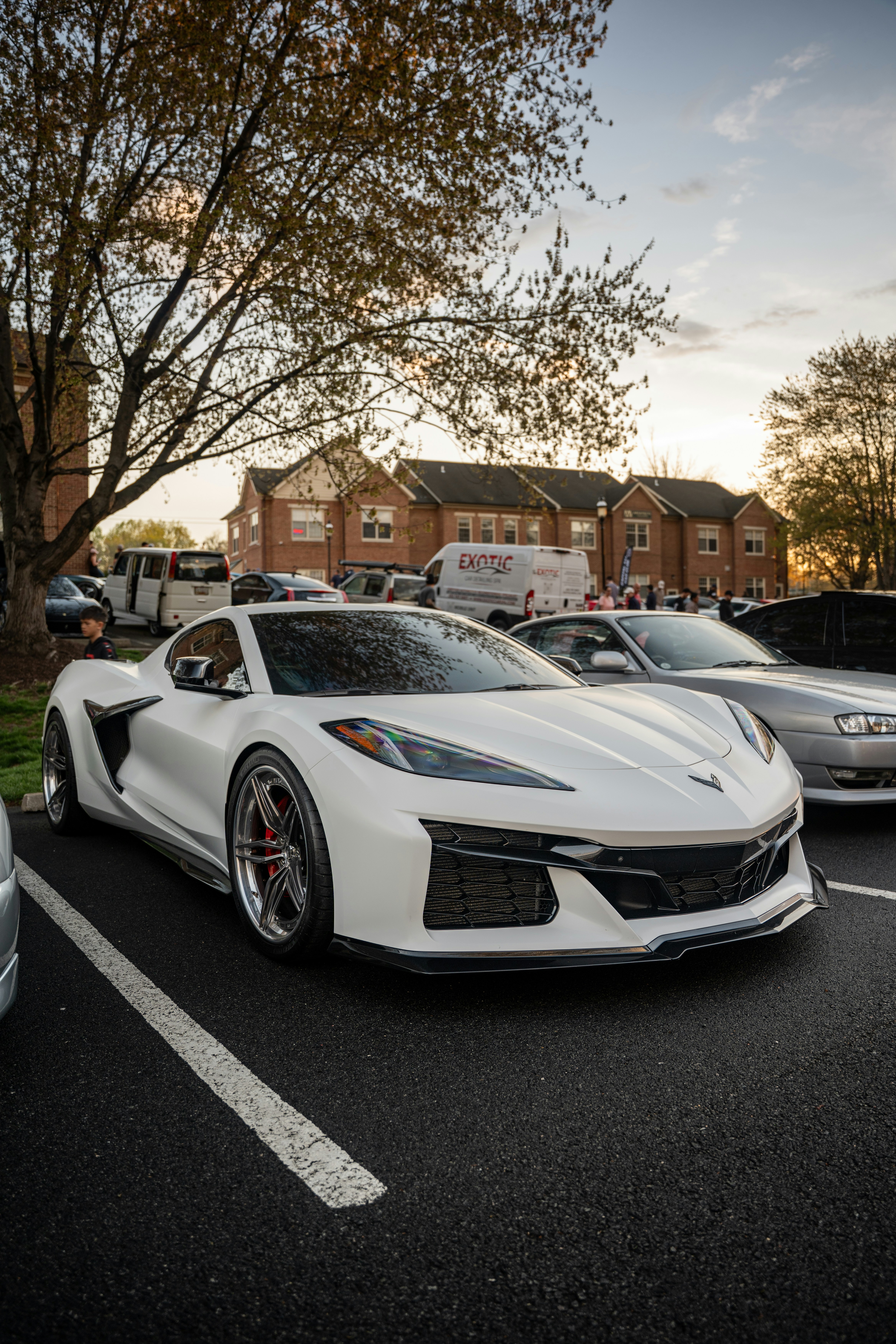 White Corvette at Sunset: A Sleek Streak in the Parking Lot
