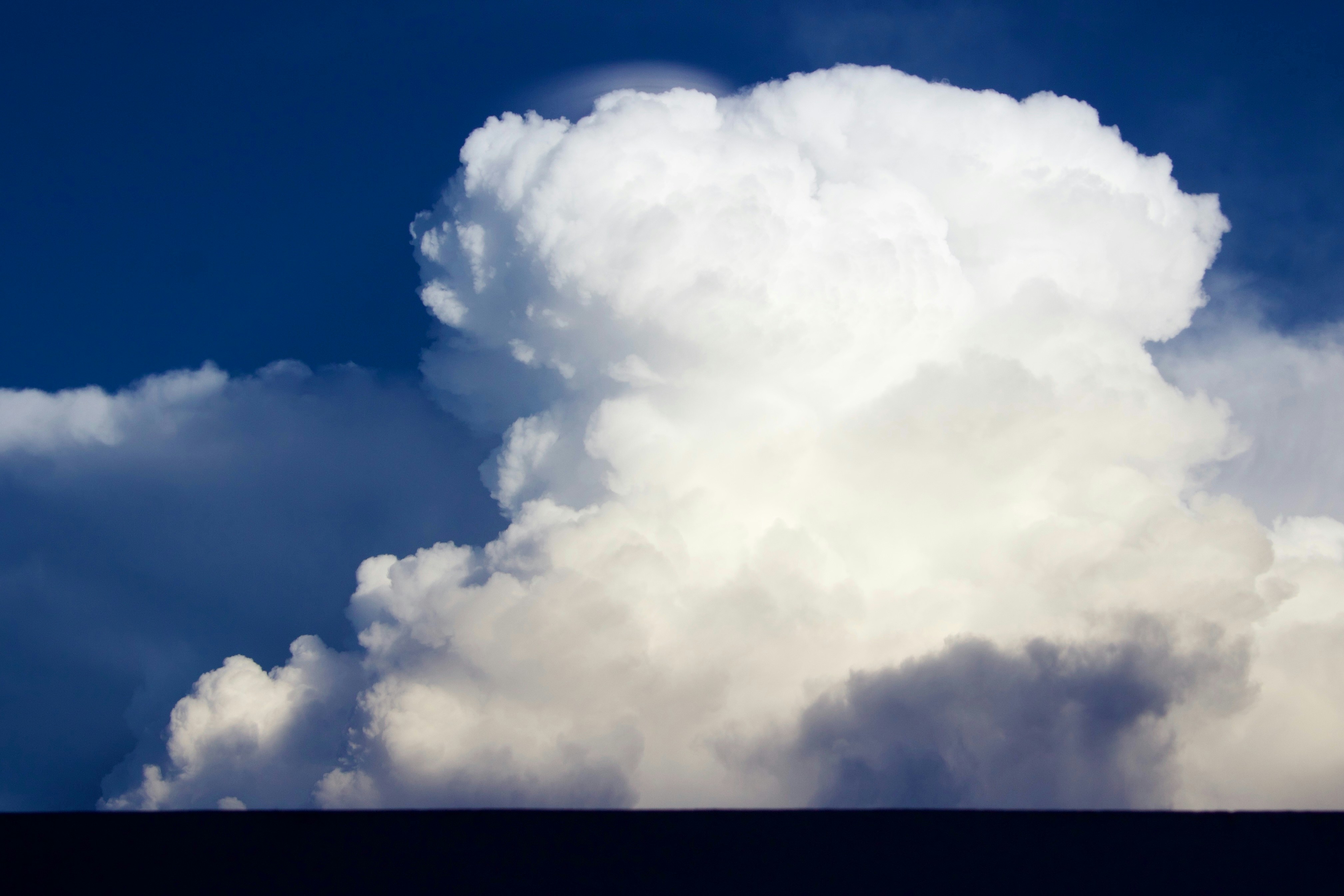 Cloud Tower Over a Dark Horizon