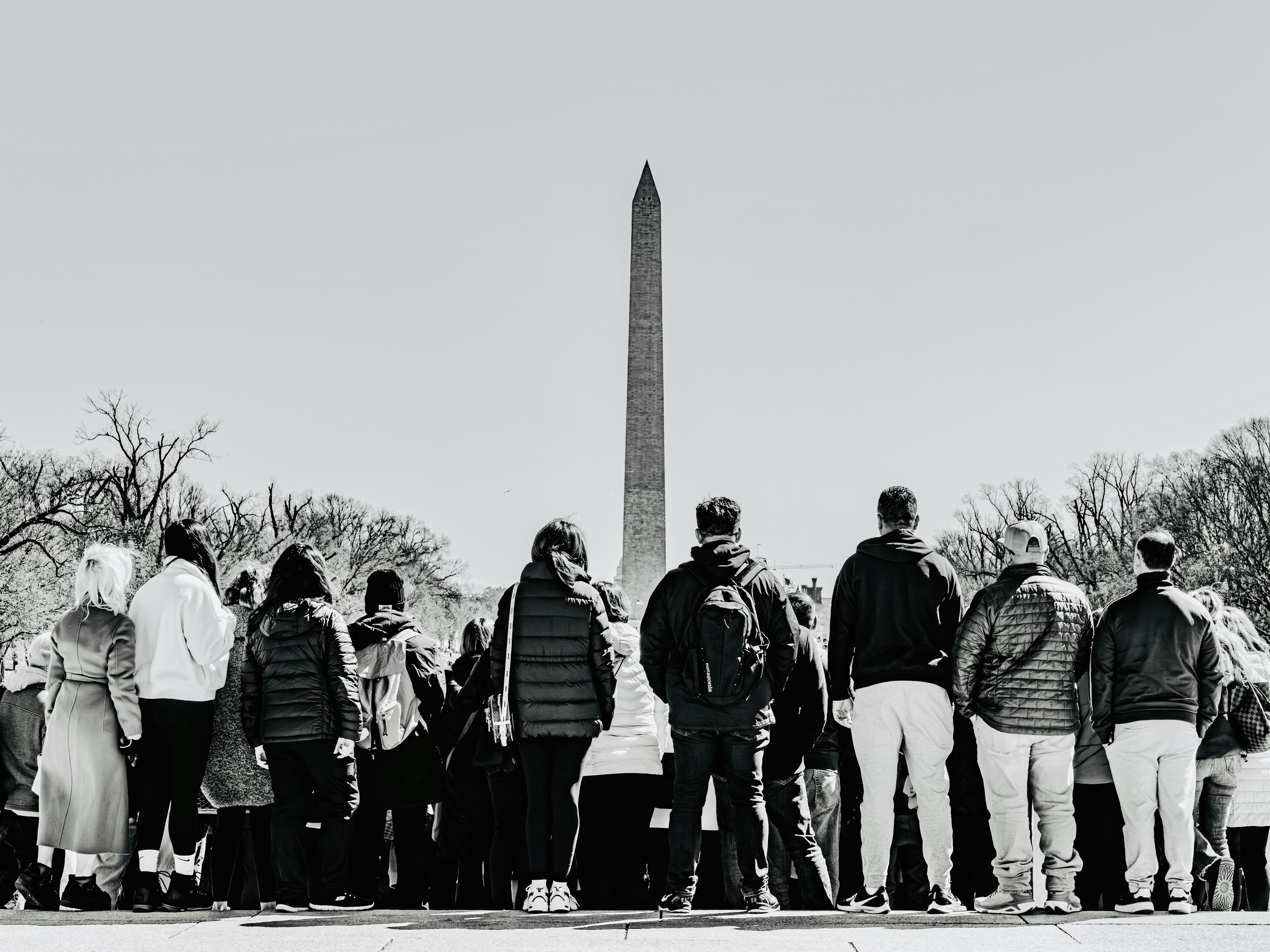 Centered Crowd Before the Obelisk: A Quiet Gathering at Dusk
