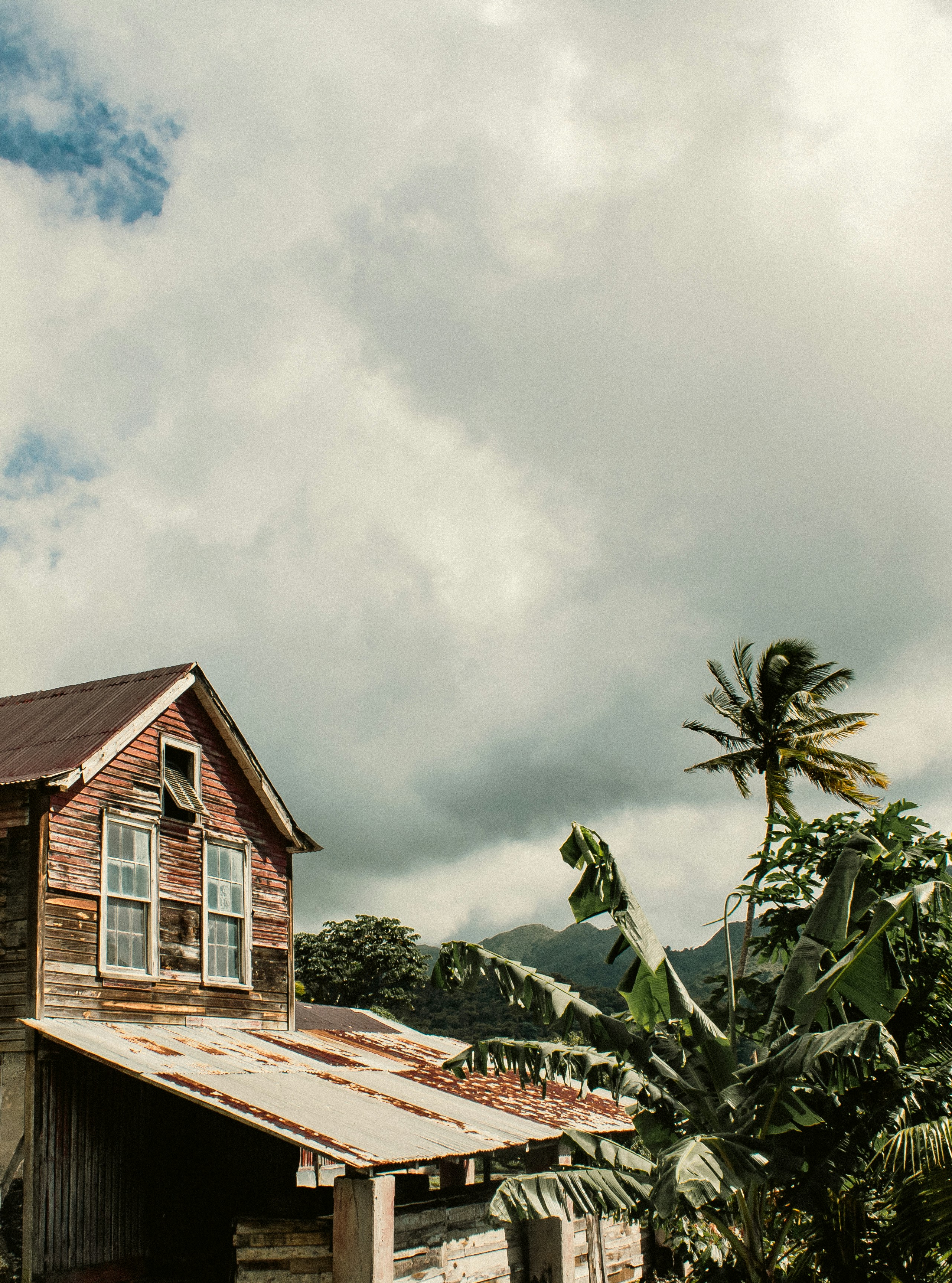 Weathered Wooden House Beneath a Stormy Sky