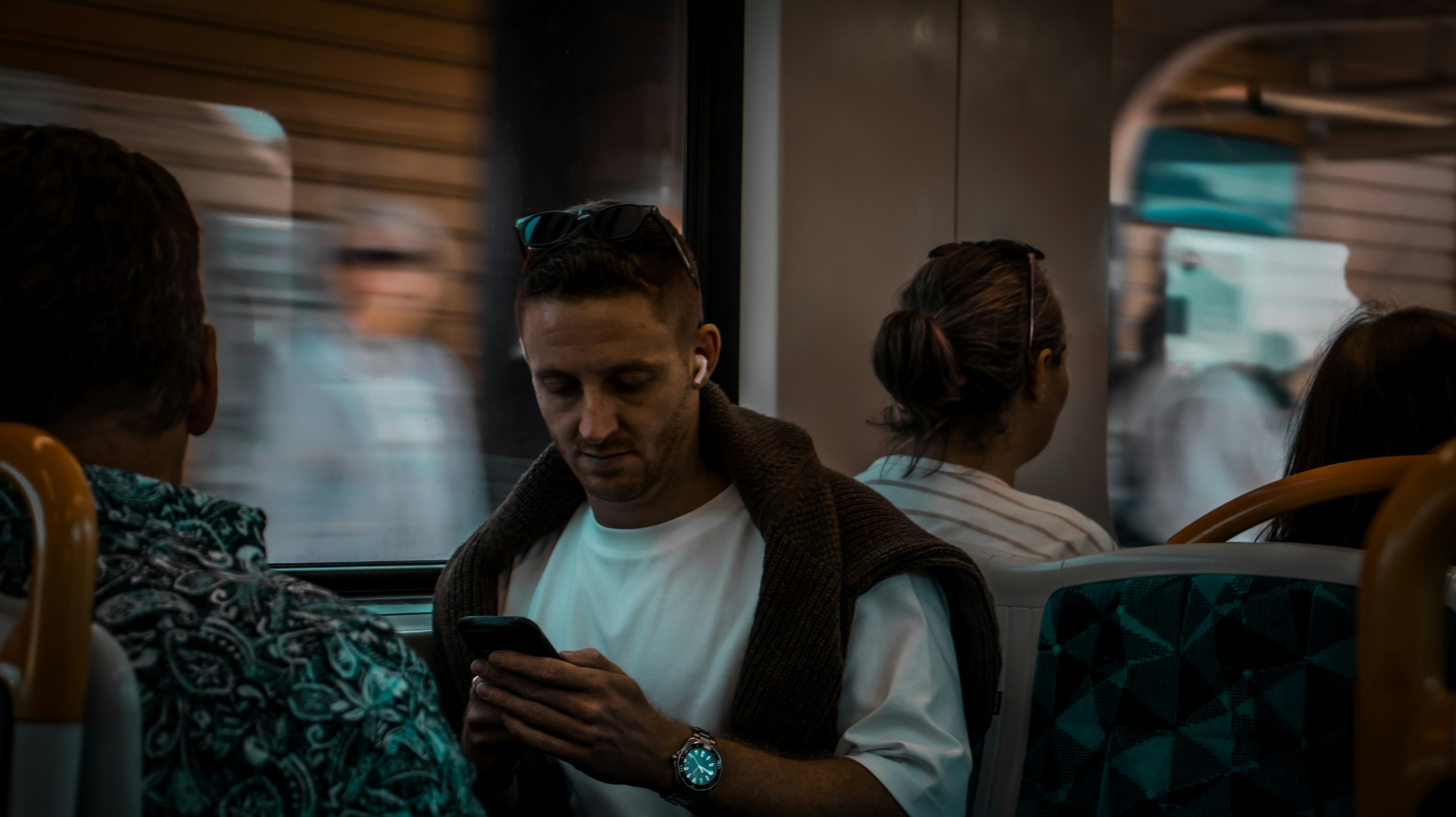 Passenger in Focus: Quiet Moment with a Phone in a Moving Train