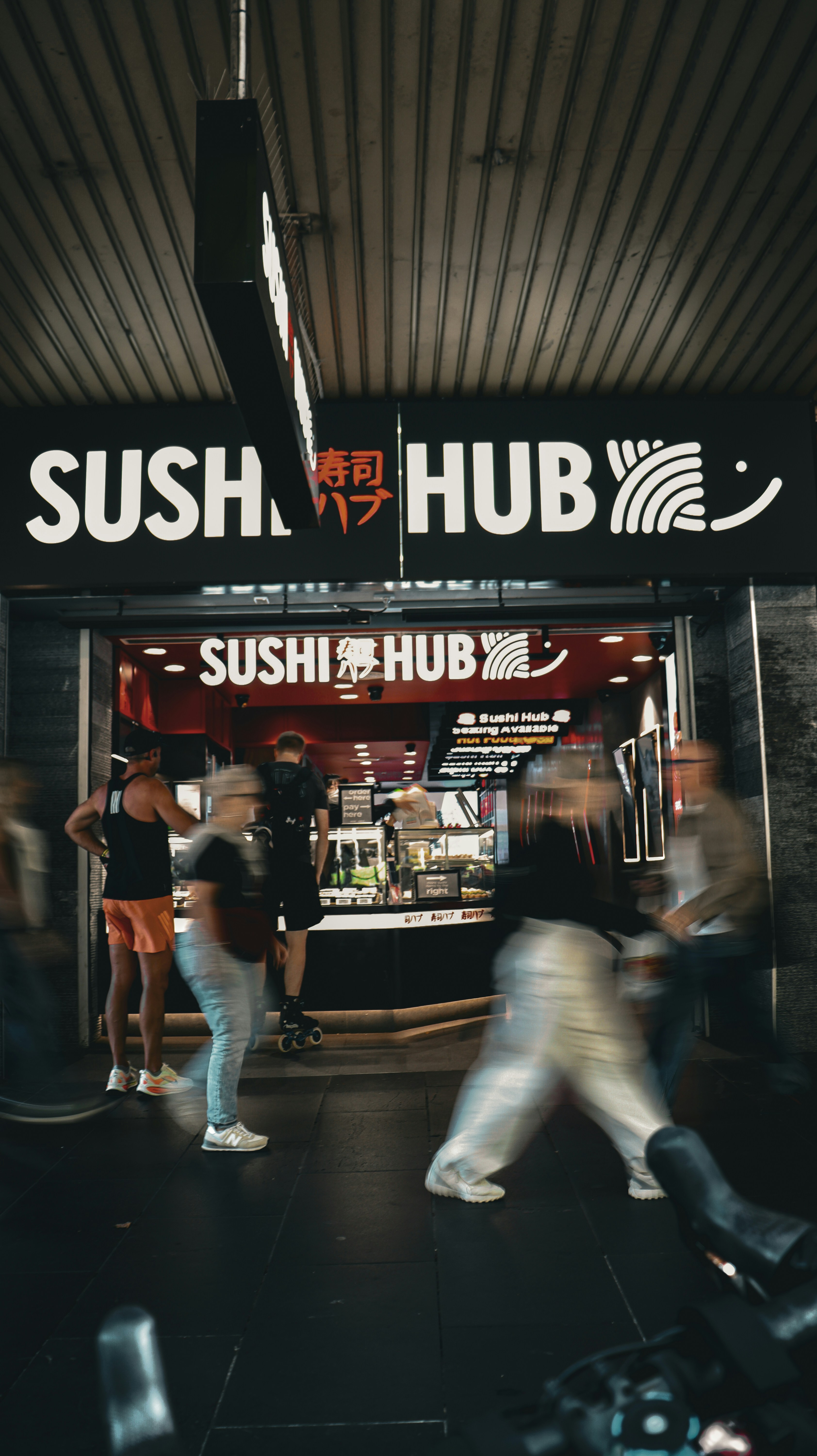 Central Sushi Hub: Motion and Neon at the Entrance