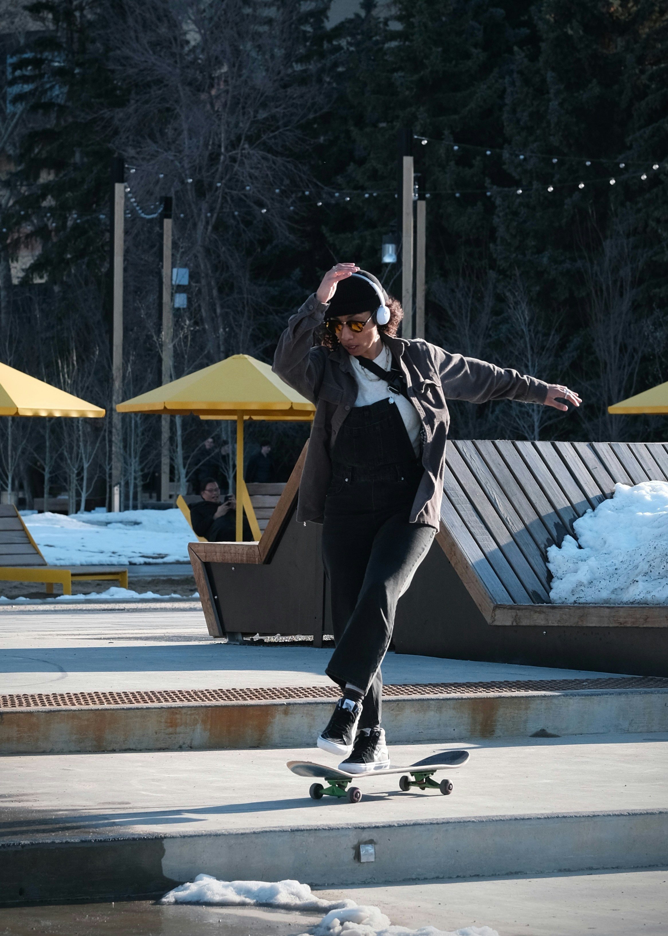 Skateboarder in Winter Light Glides Across a Concrete Stage