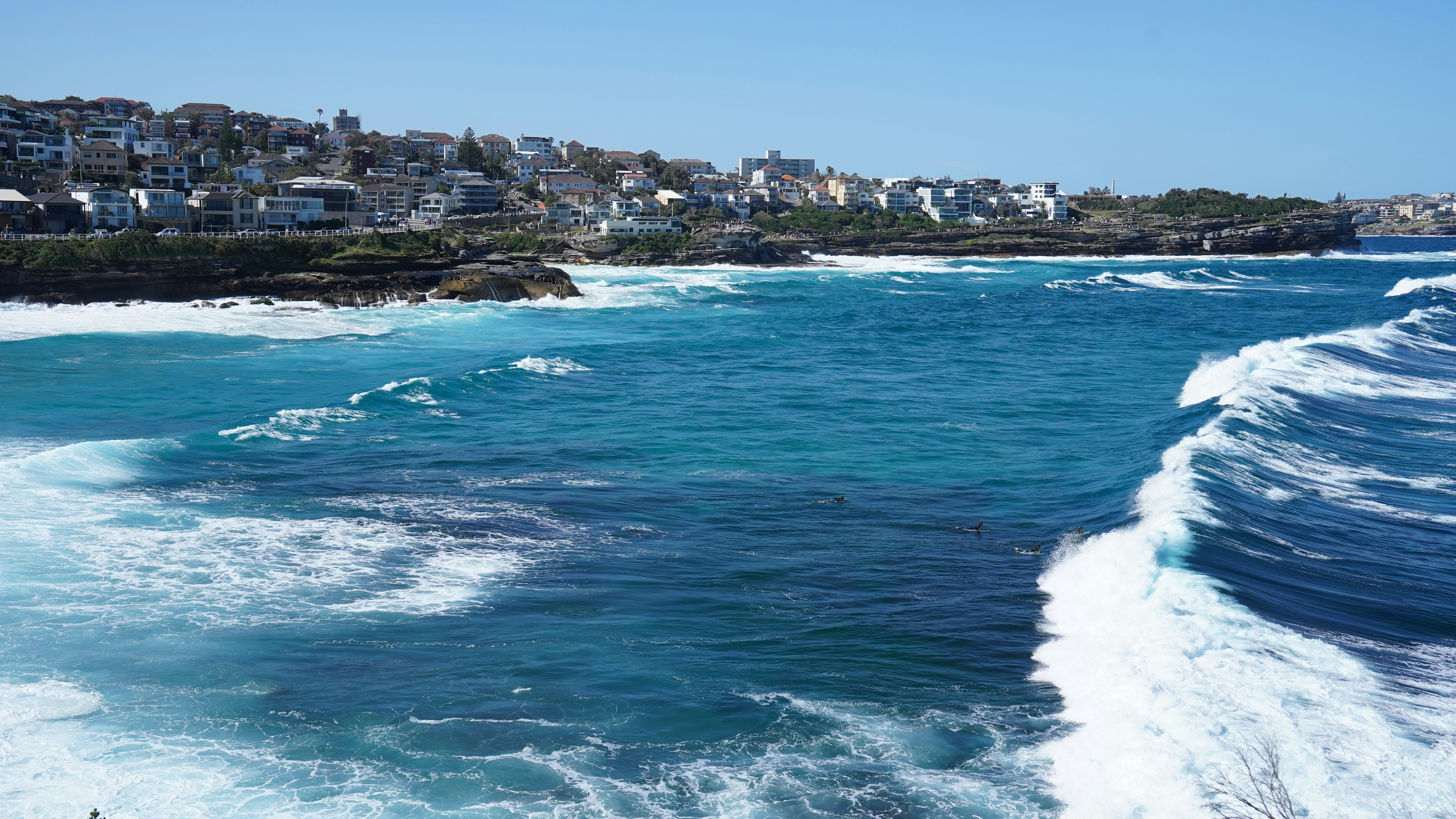 Coastal Crest: Breaker Line Over a Quiet Town