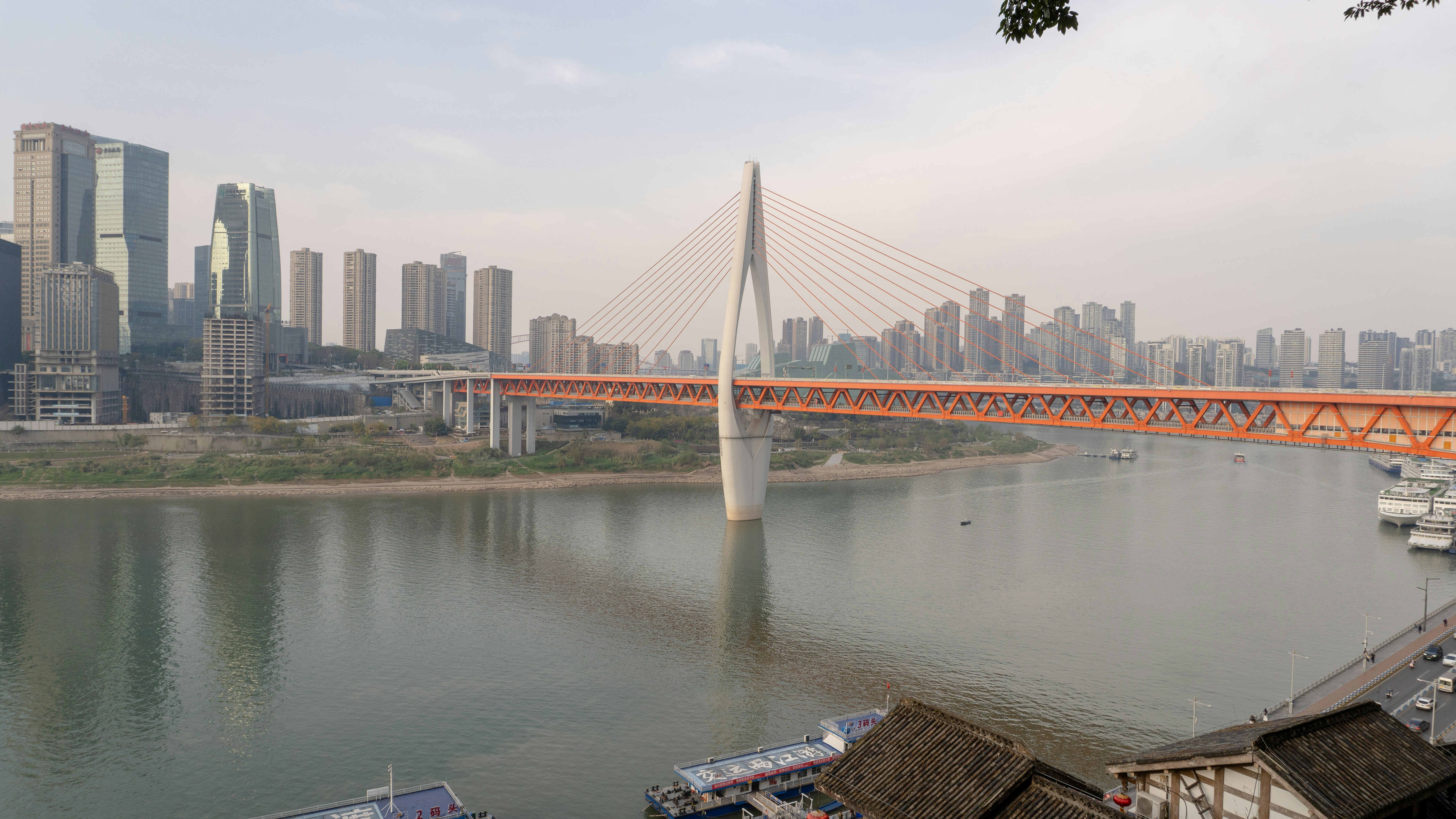 Red Cable-Stayed Arc: City Skyline and Bridge Glow