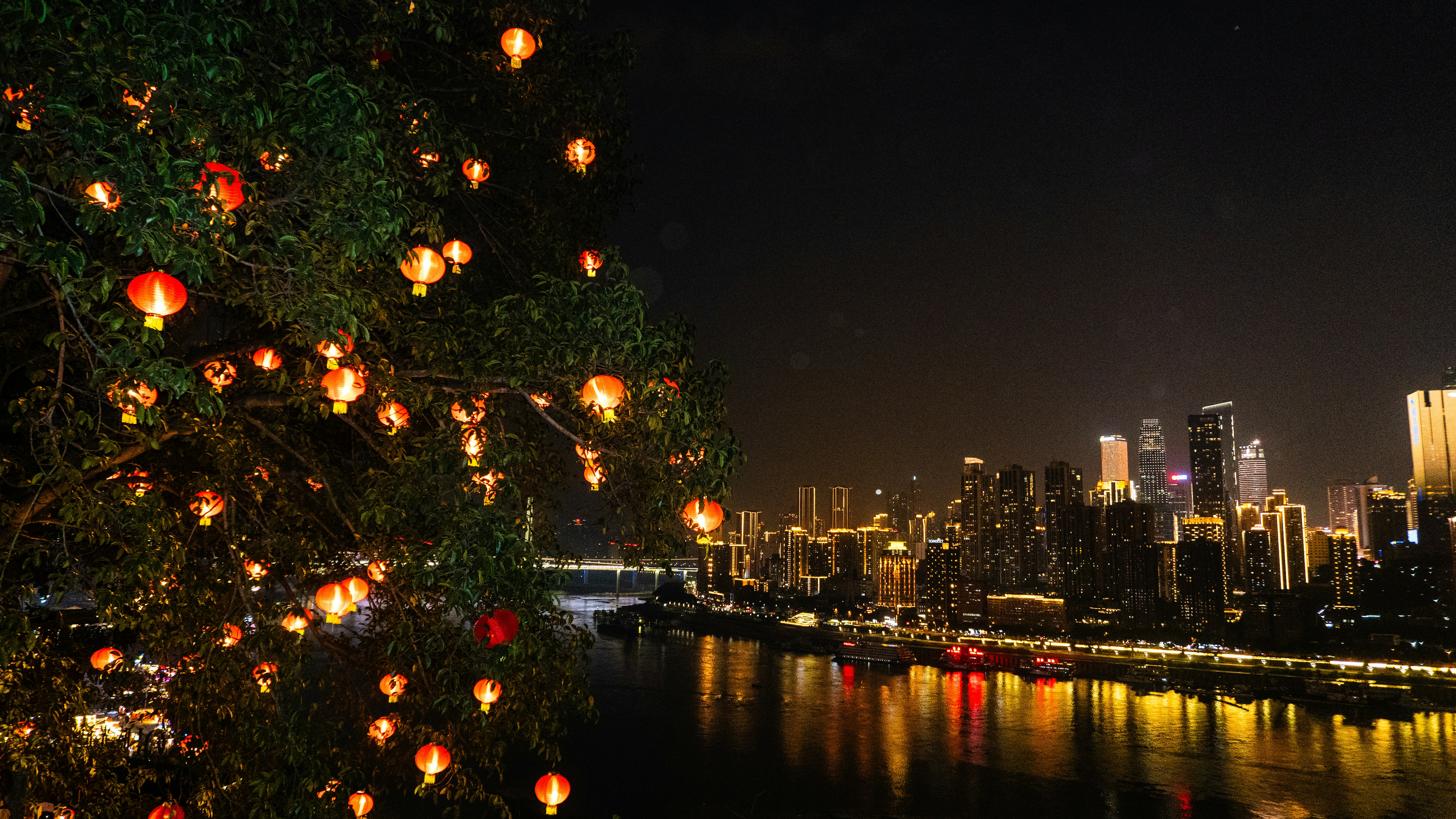 Lanterns over the River: Night Skyline Reflections