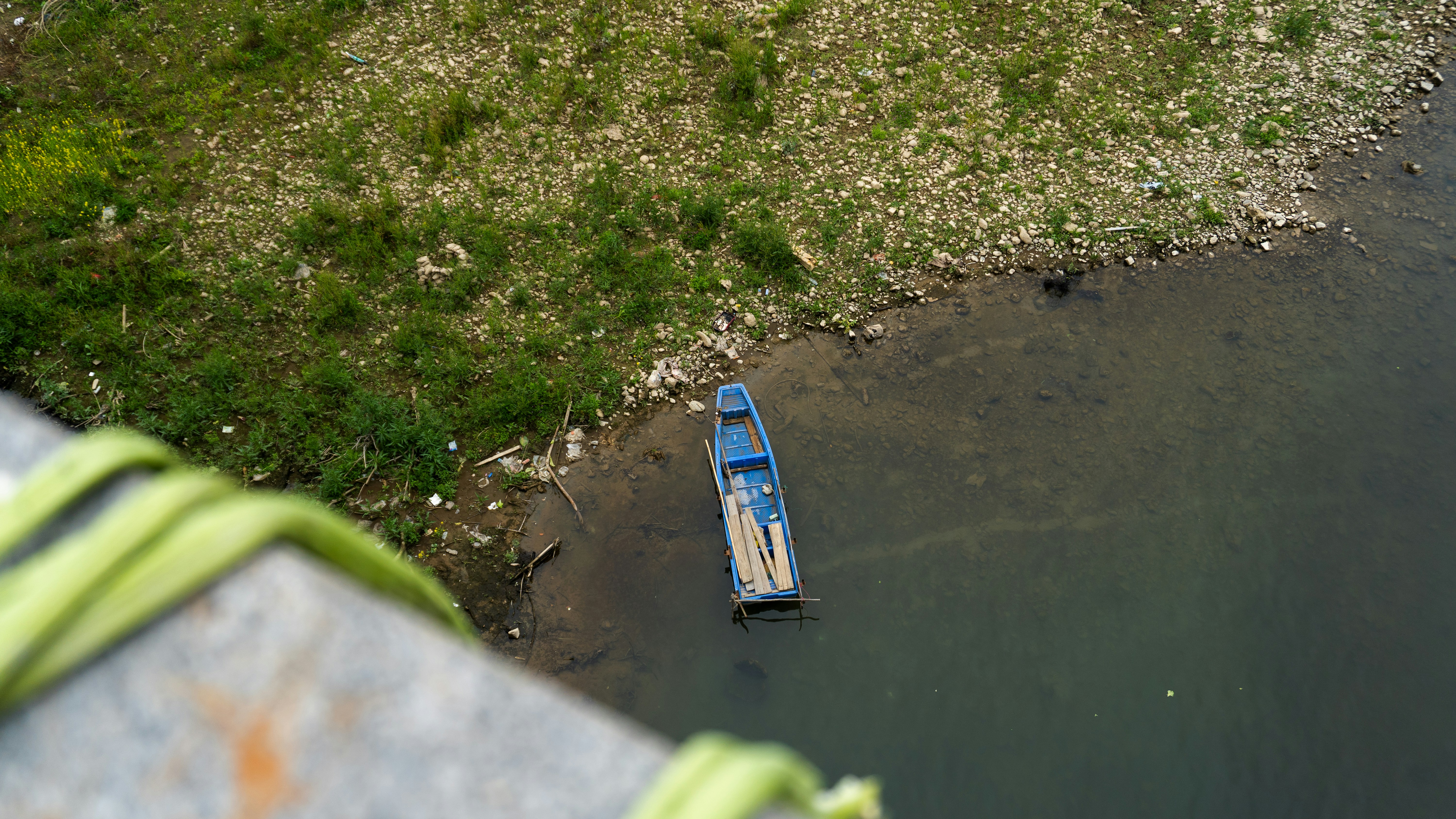 Blue Boat at the Riverbend: A Quiet Ditch Scene from Above