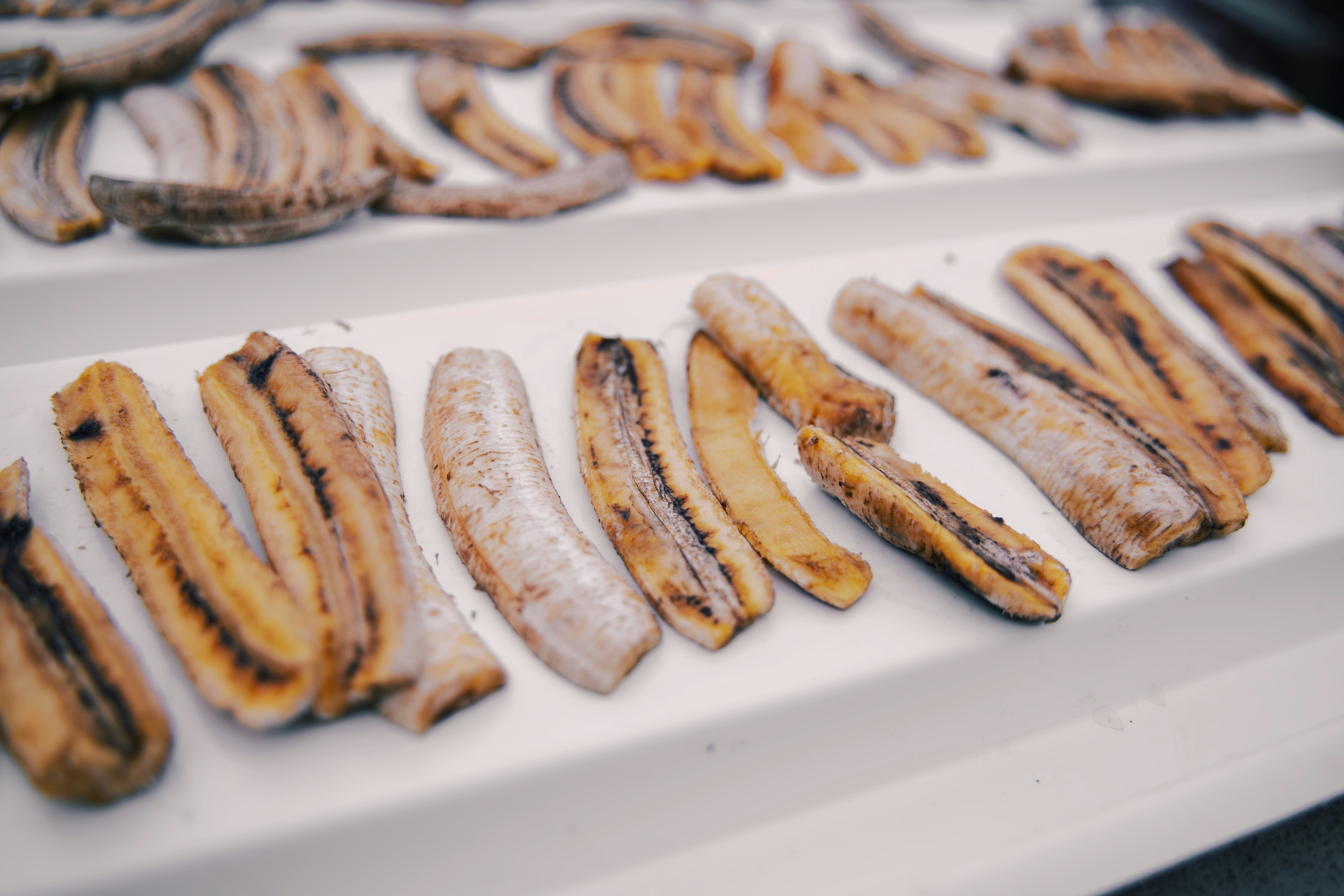 Rows of Dried Banana Chips on a White Display