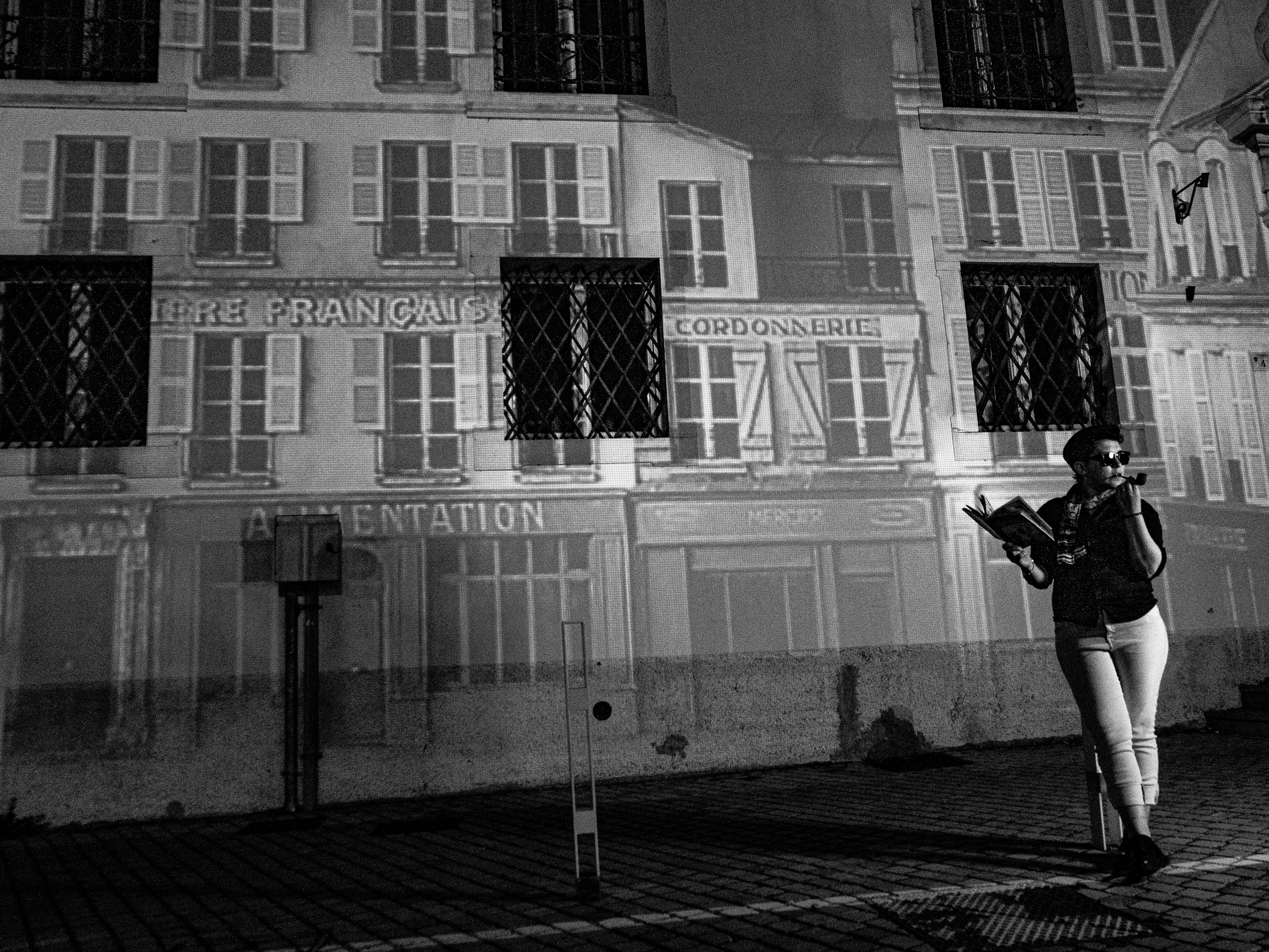 Night in Framed Paris: A Street Study with a Lively Reader