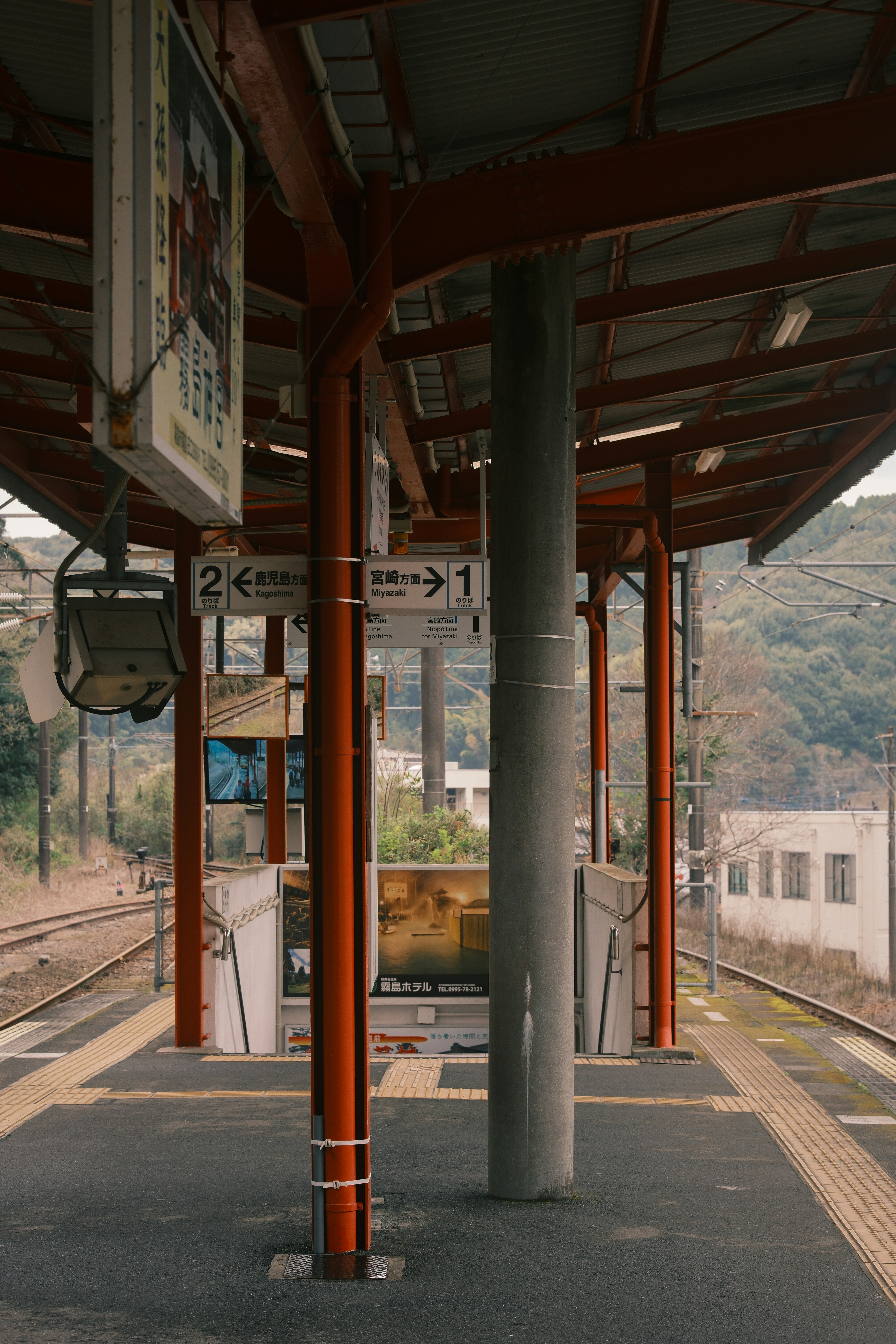 Quiet Platform Echoes: Red Columns and Distant Tracks