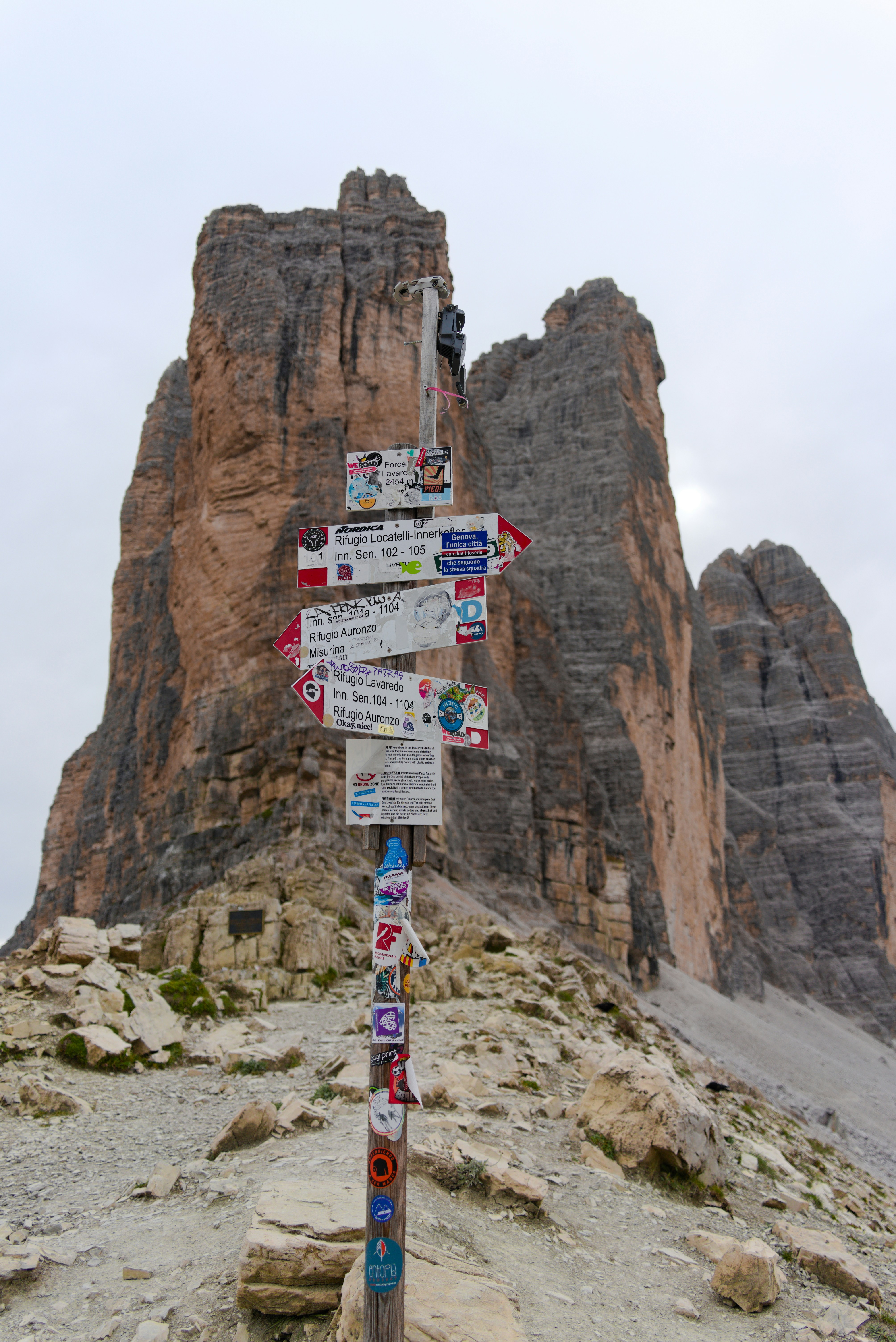 Trail Signpost at the Pass: A Staircase of Directions Amidst Jagged Peaks
