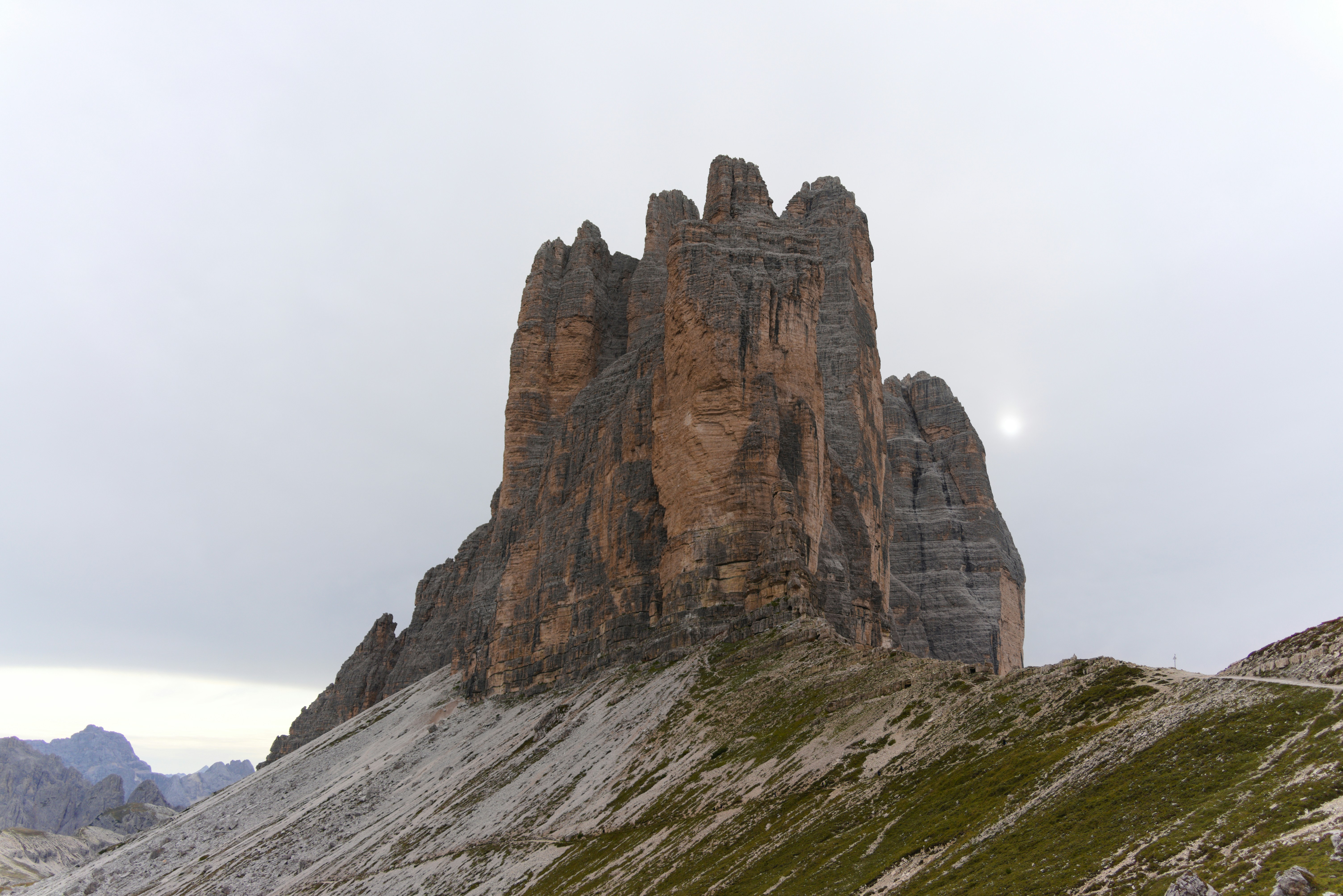 Stone Sentinels: The Peak Stands Over a Rugged Slope
